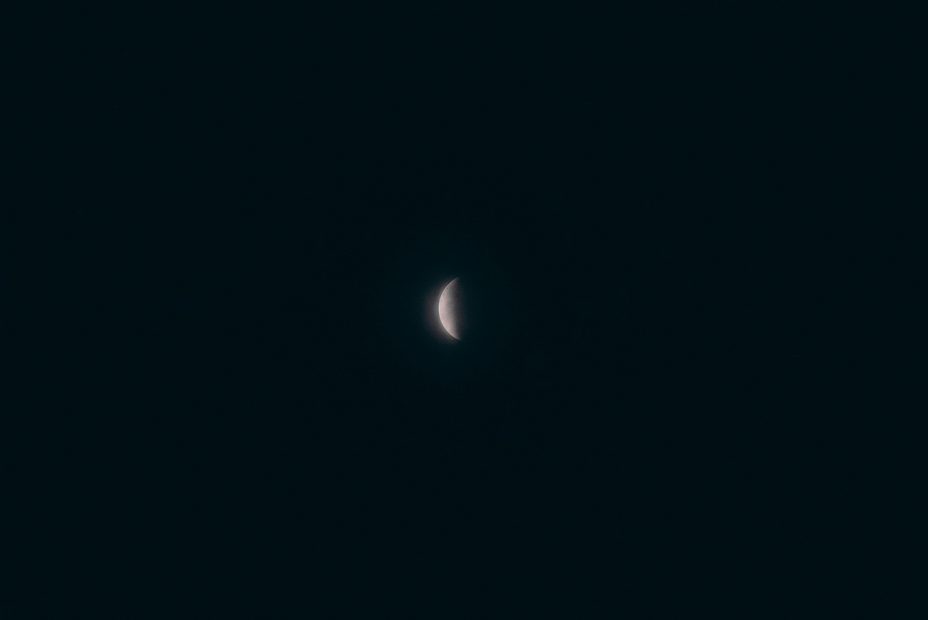 Lone Crescent: Moonlit Sliver in a Velvet Night