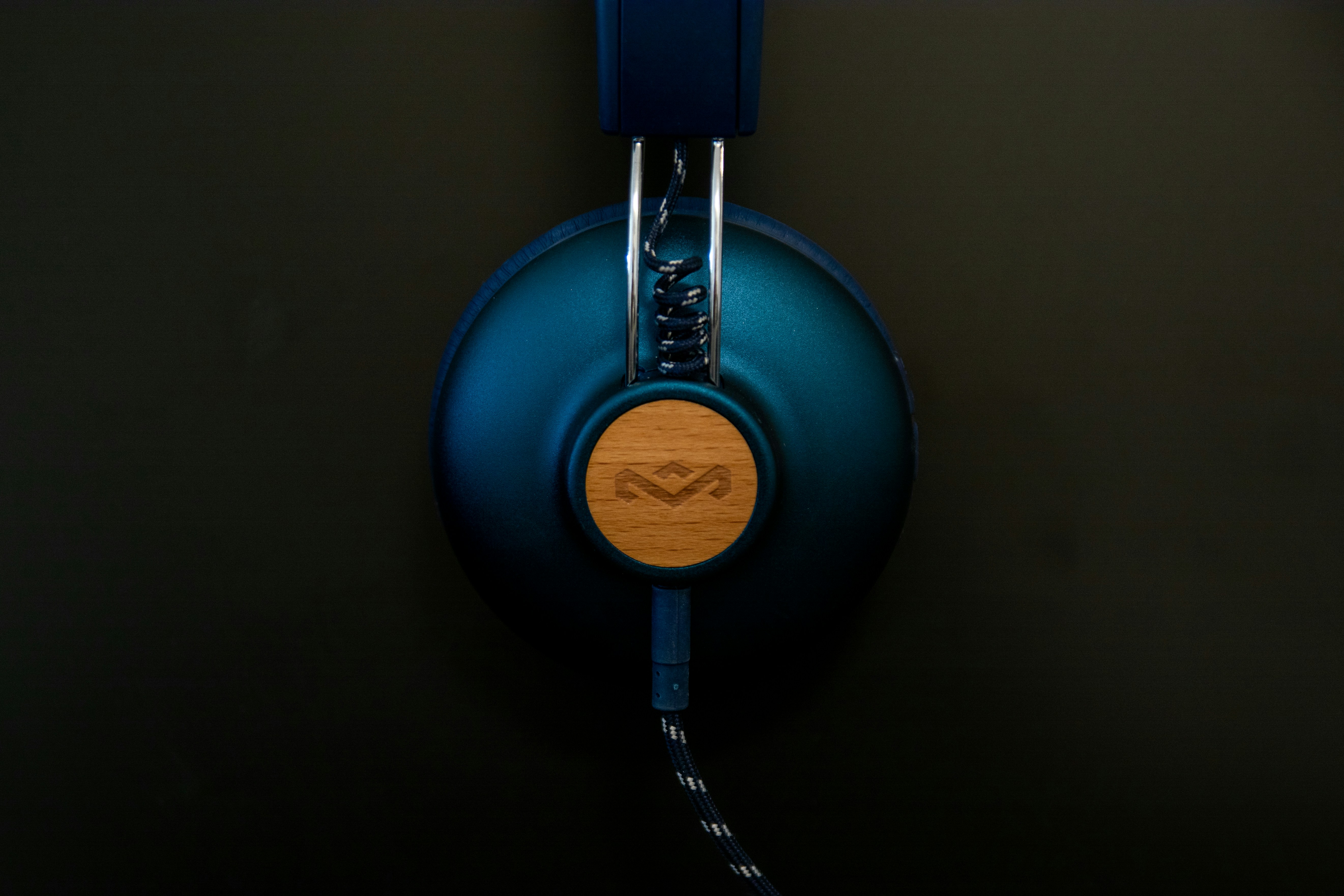 Cobalt Ring: A Macro Portrait of a Headphone Ear Cup with a Wooden Emblem