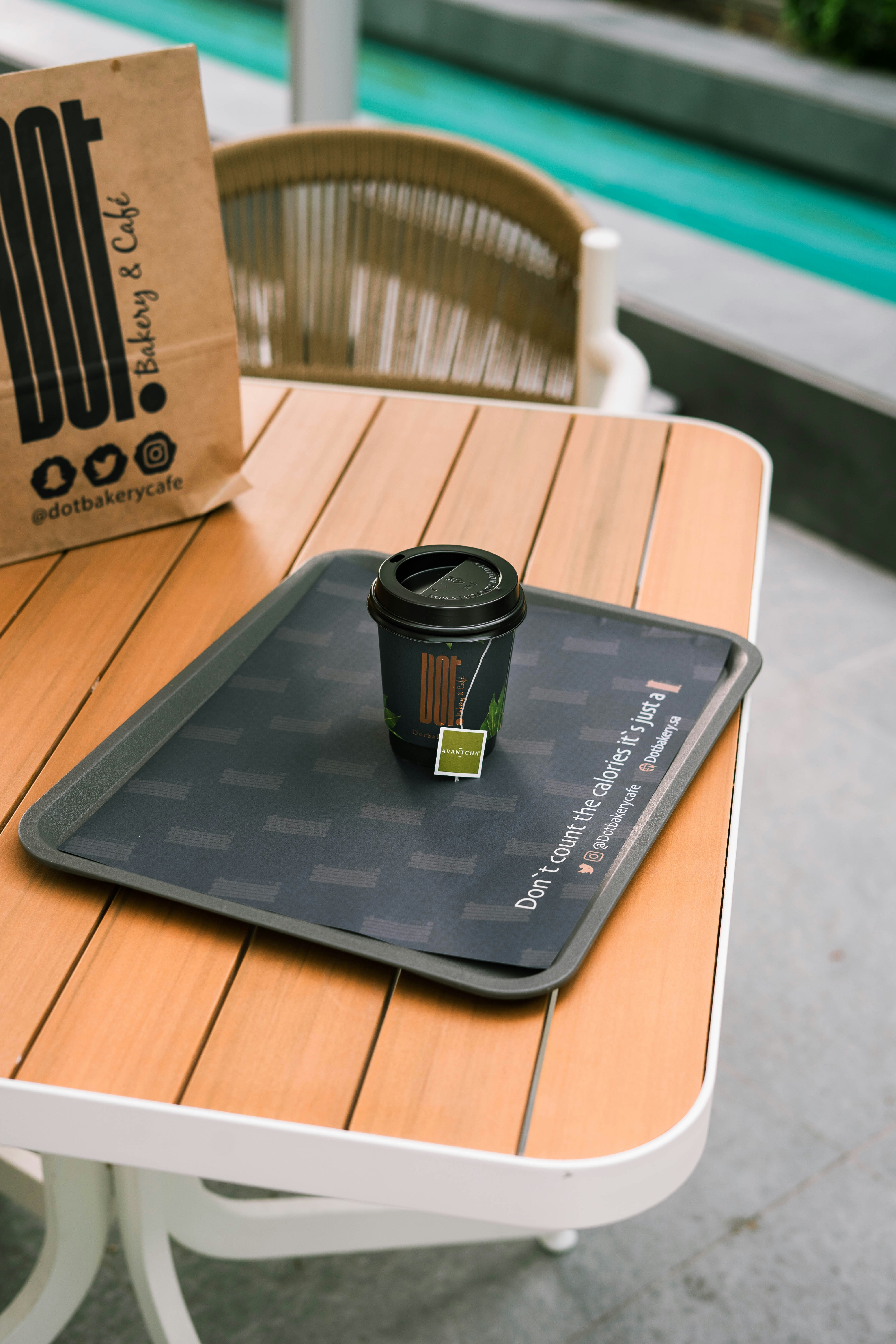 a cup of coffee sitting on top of a table