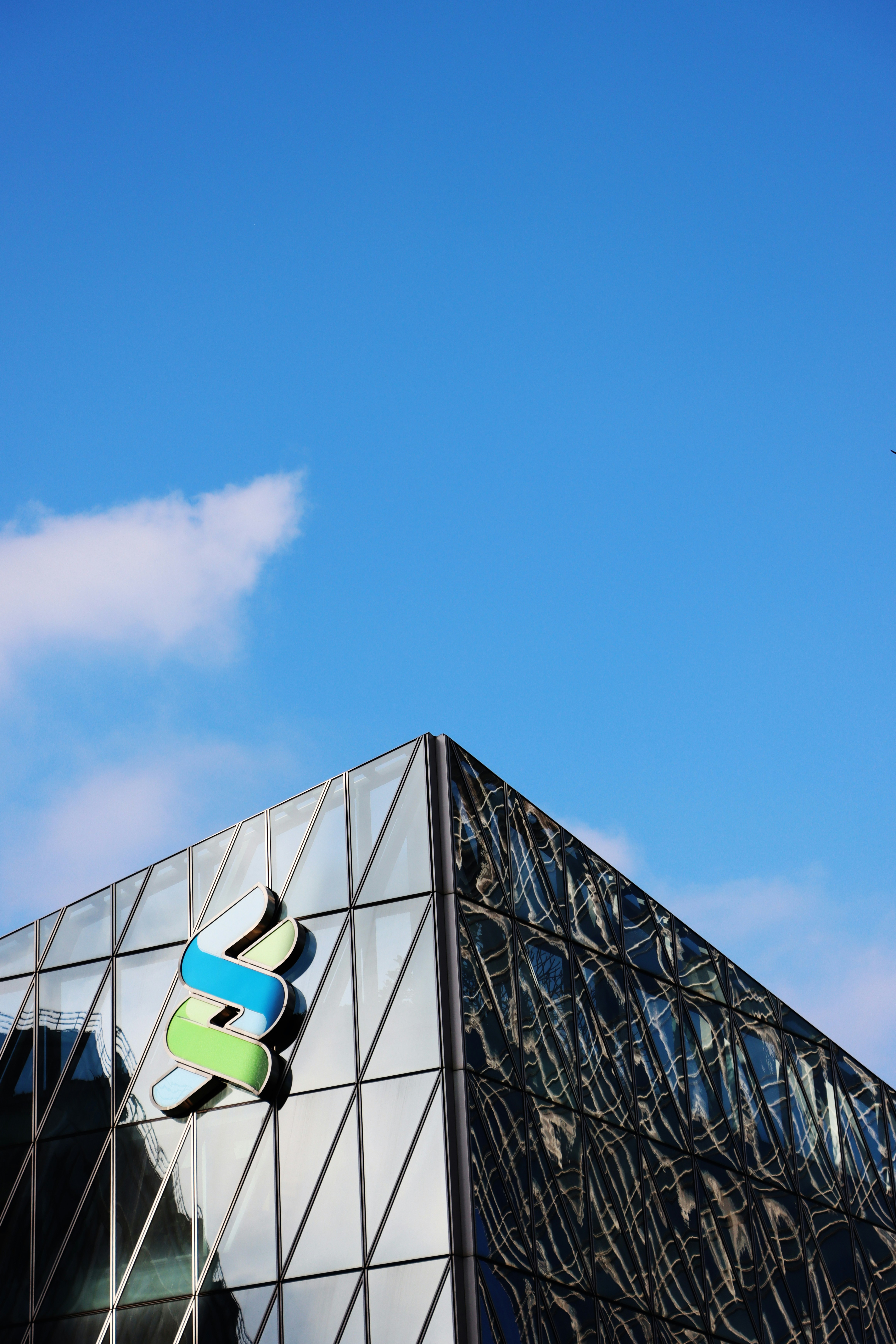 Geometric Glass and Colorful Emblem: A Cornerstone of Modern Architecture
