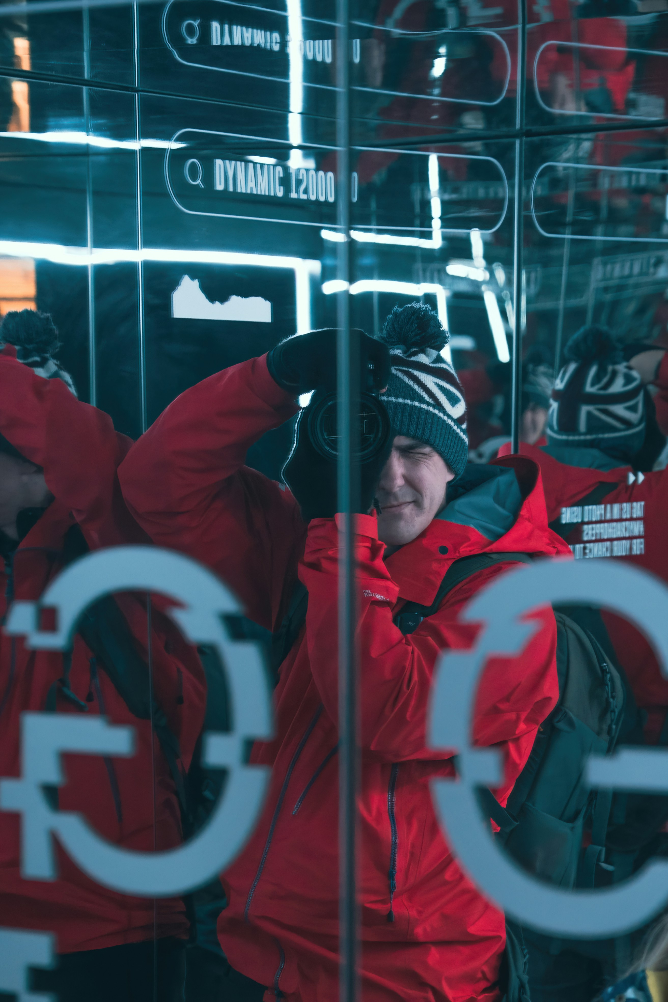 Mirror Frame, Real Person: A Gloved Photographer Captures the Moment Inside a Red-Jacketed Corridor
