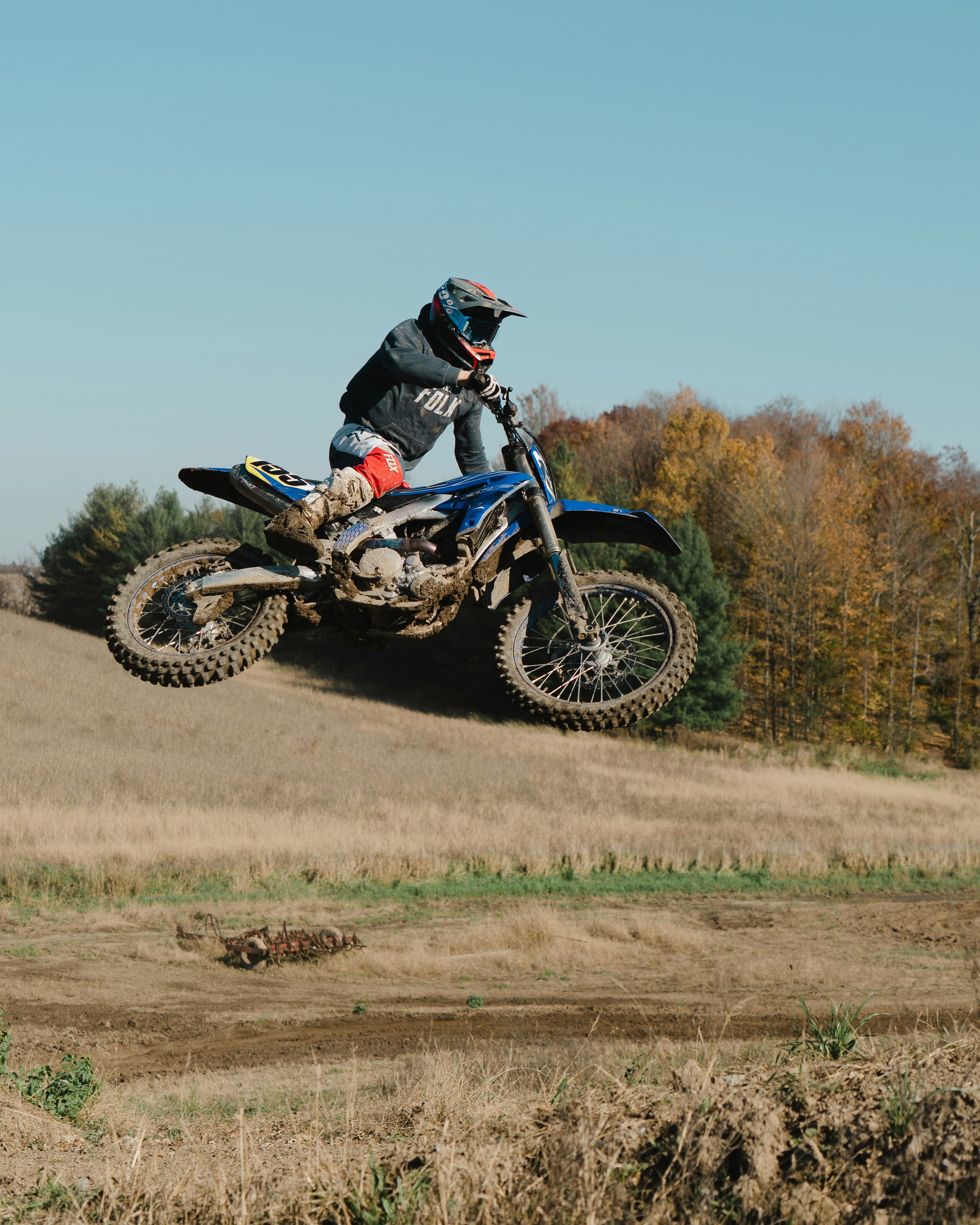 Autumn Airride: A Dirt Bike Arches Over a Sunlit Field