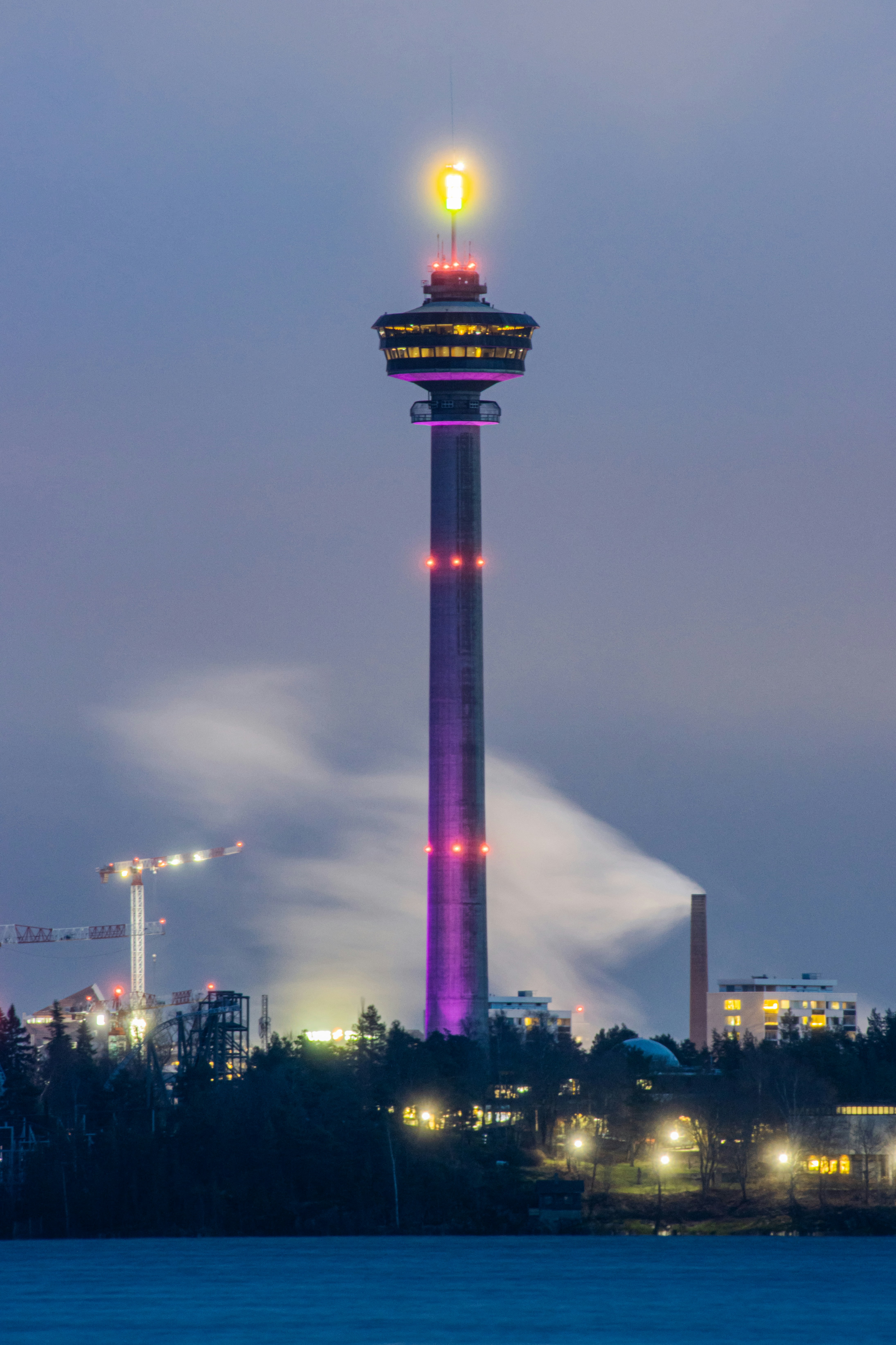 Purple Beacon Over the Waterfront: A City Tower at Dusk