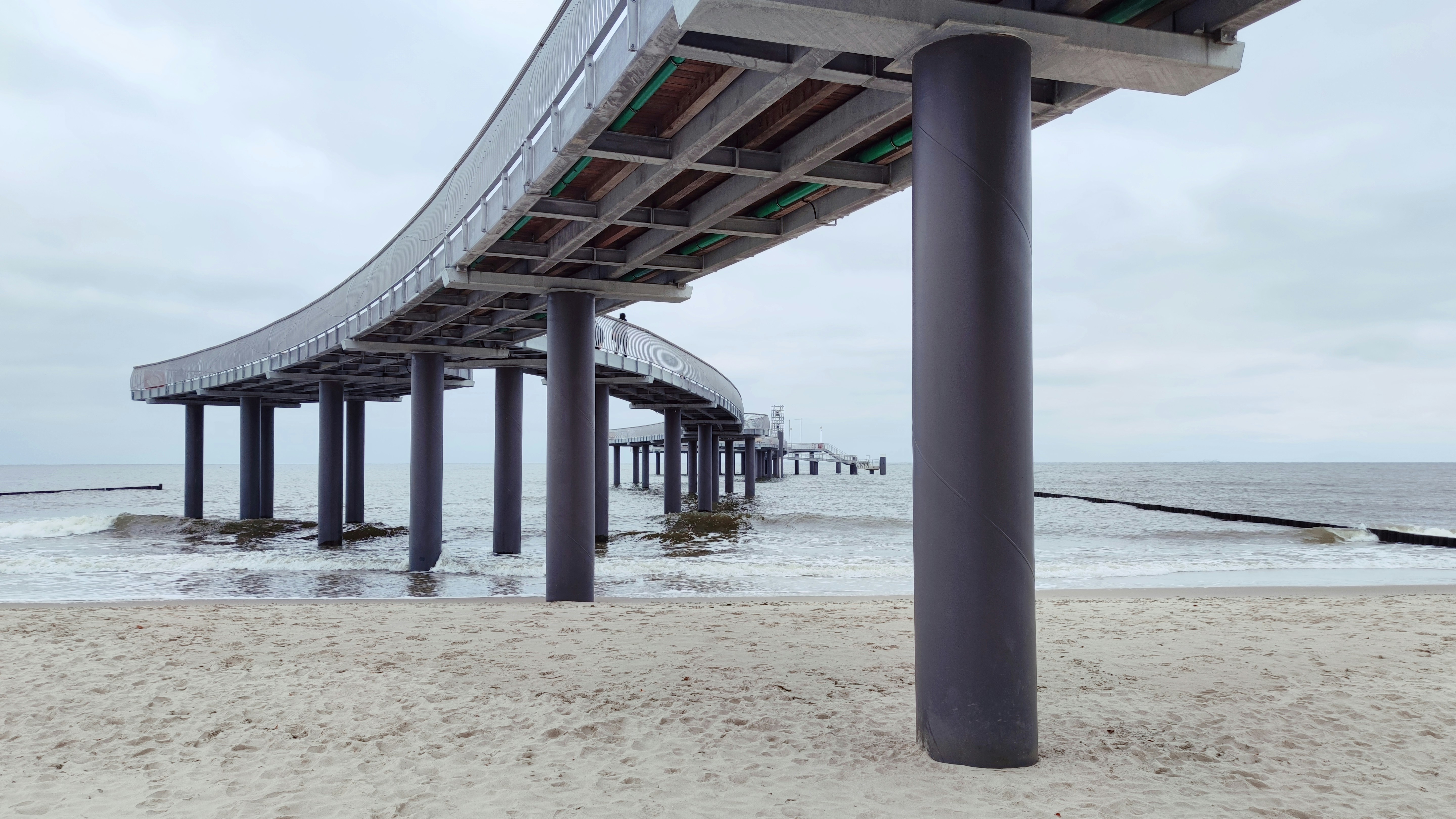 Curve of Steel and Sea: Pier Reaches Toward a Muted Horizon