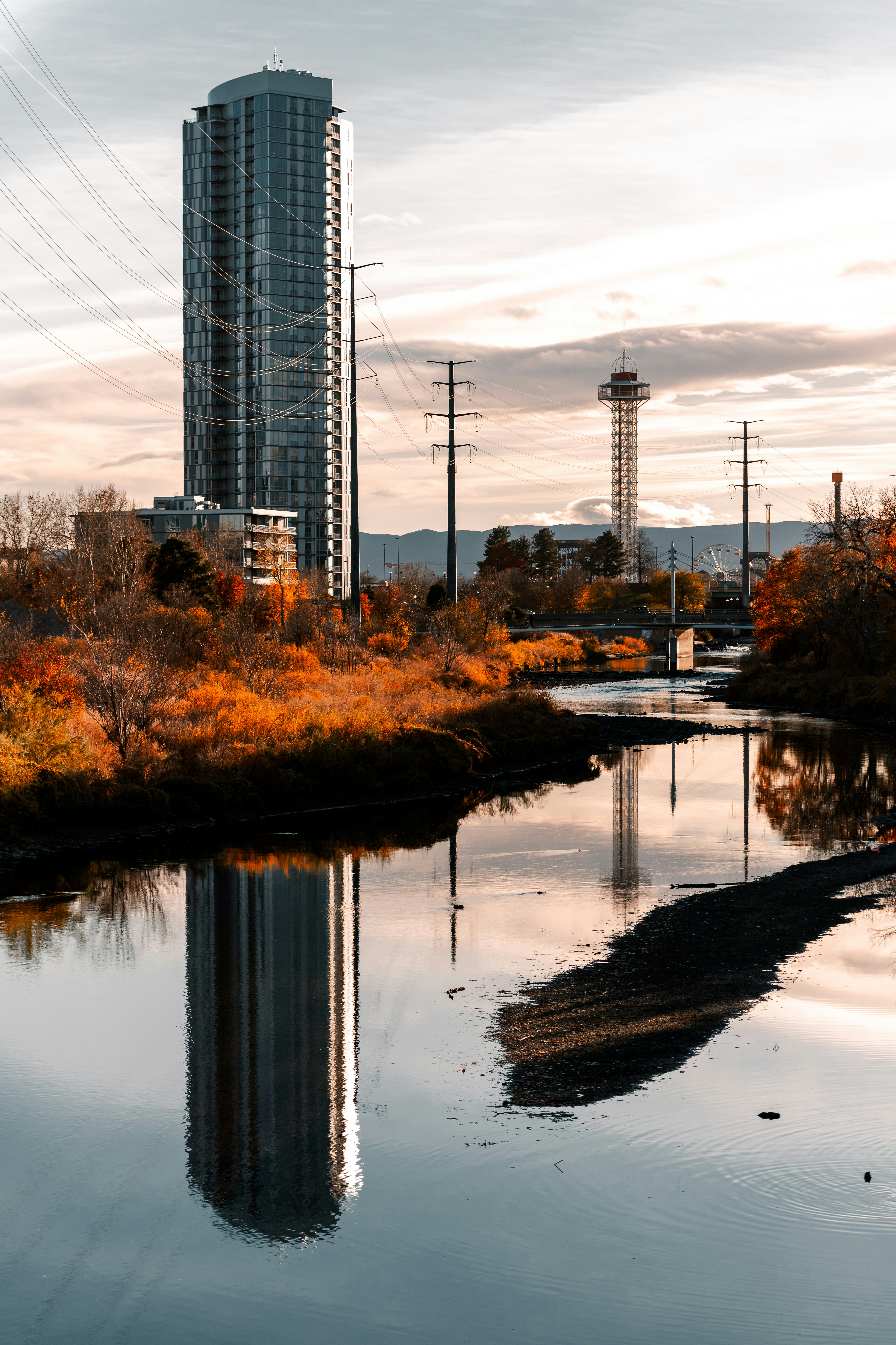 a body of water with a tall building in the background