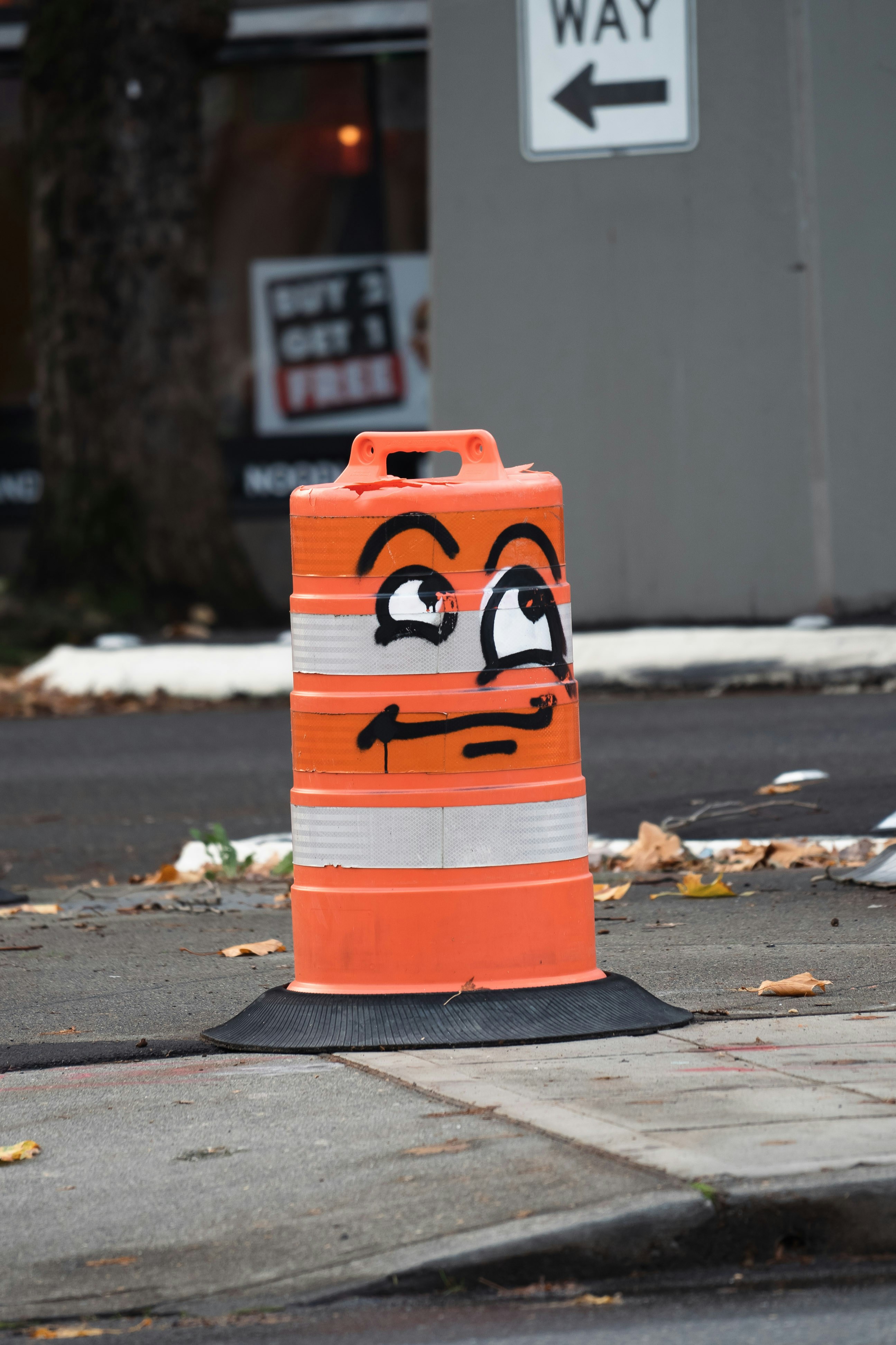 A traffic cone with a face drawn on it photo – Free Seattle Image on ...