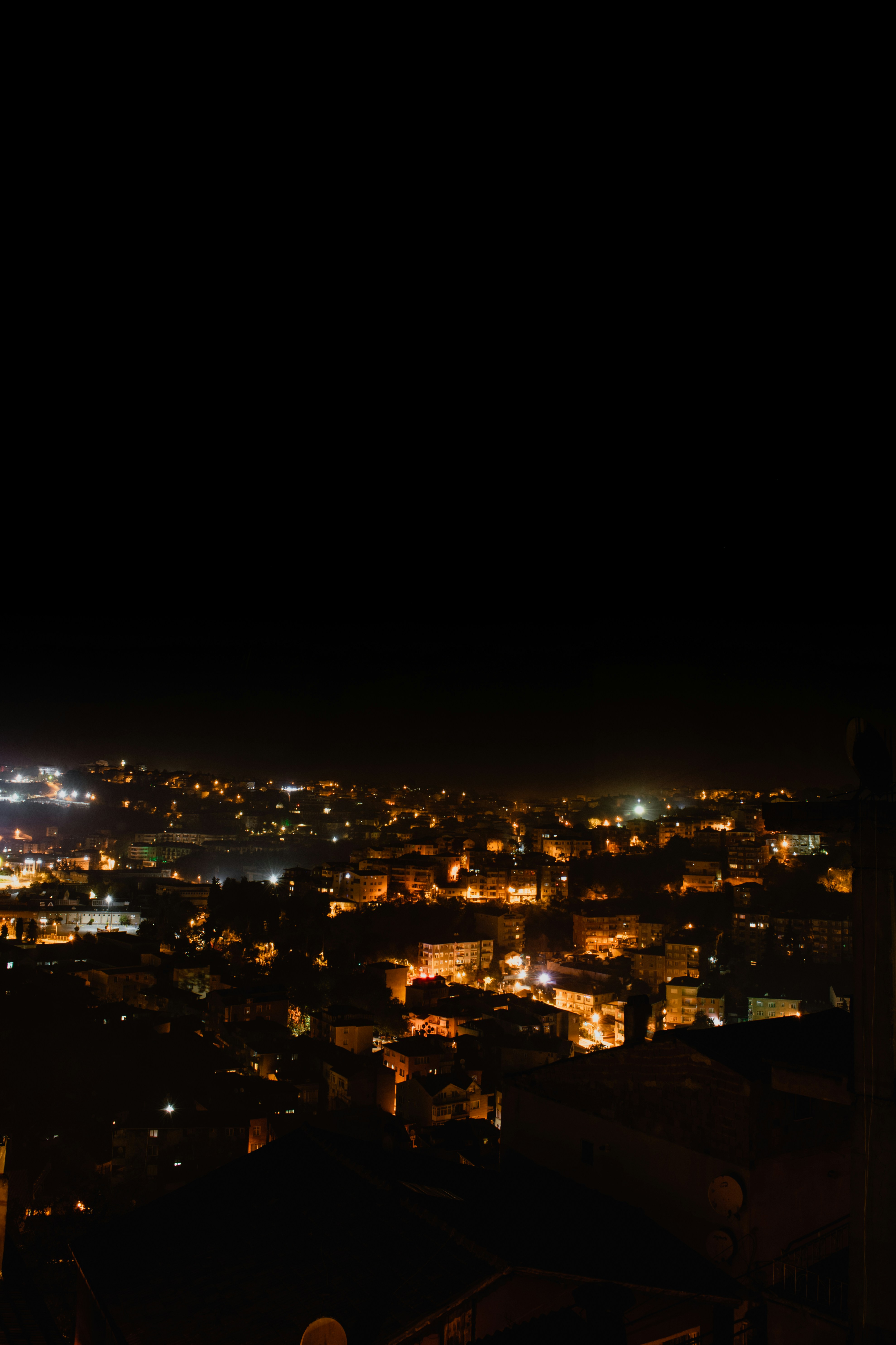 A view of a city at night from the top of a building photo – Free ...