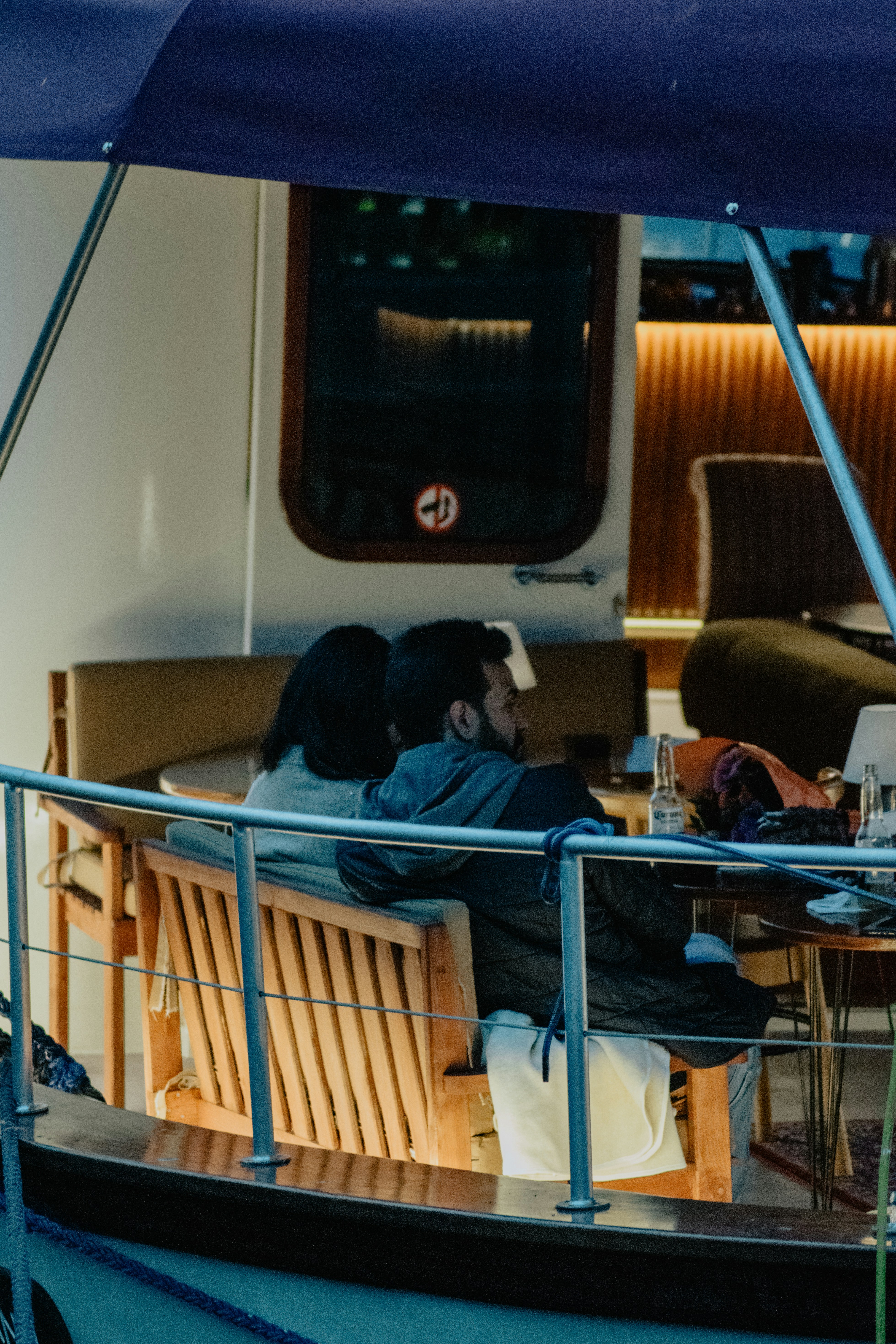 Onboard Conversation: Two Friends Resting in a Marina Lounge