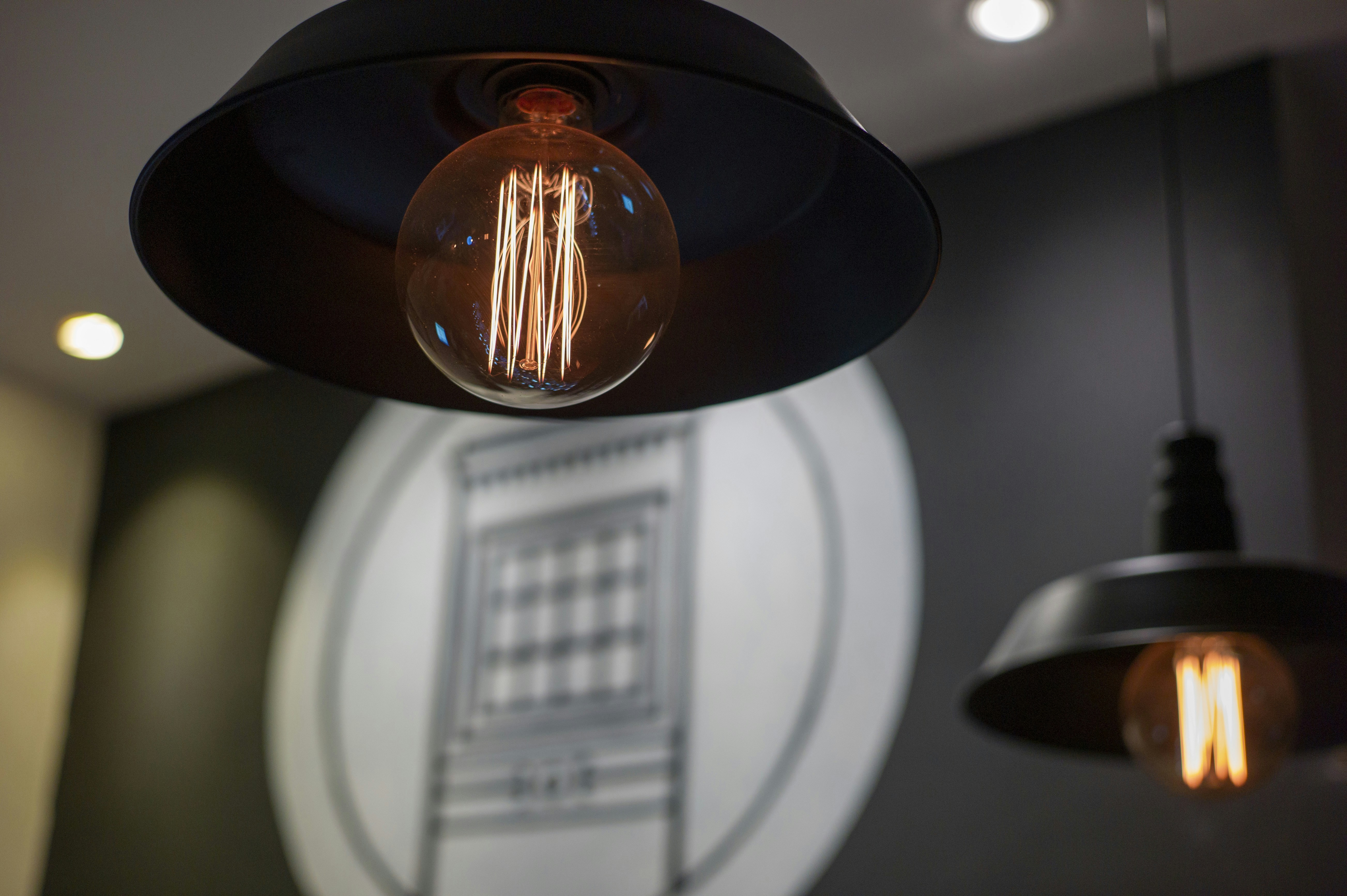 A light bulb in local craft beer | a couple of lights that are hanging from a ceiling