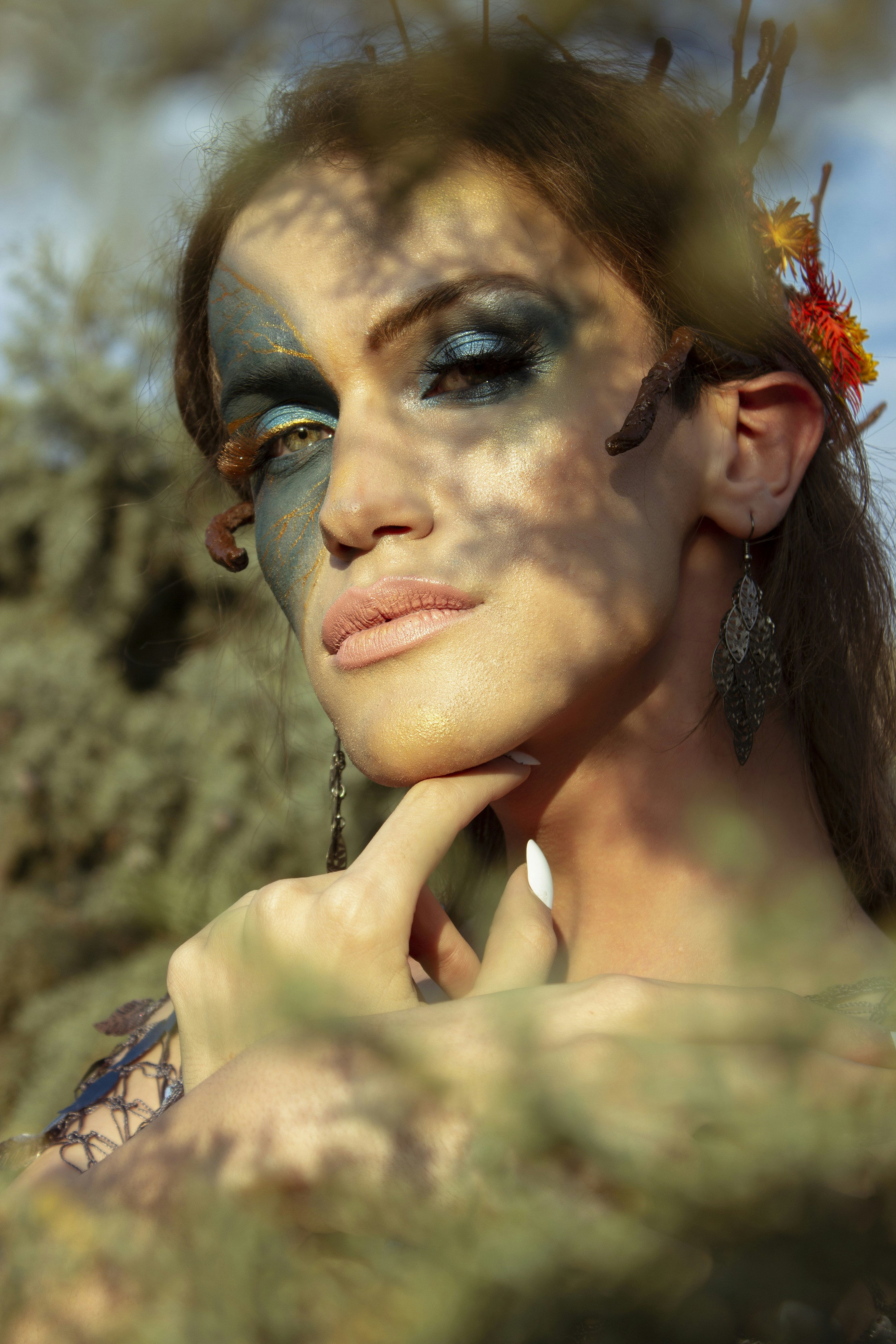 Shadowed Gaze: A Portrait in Dappled Light and Floral Adornment