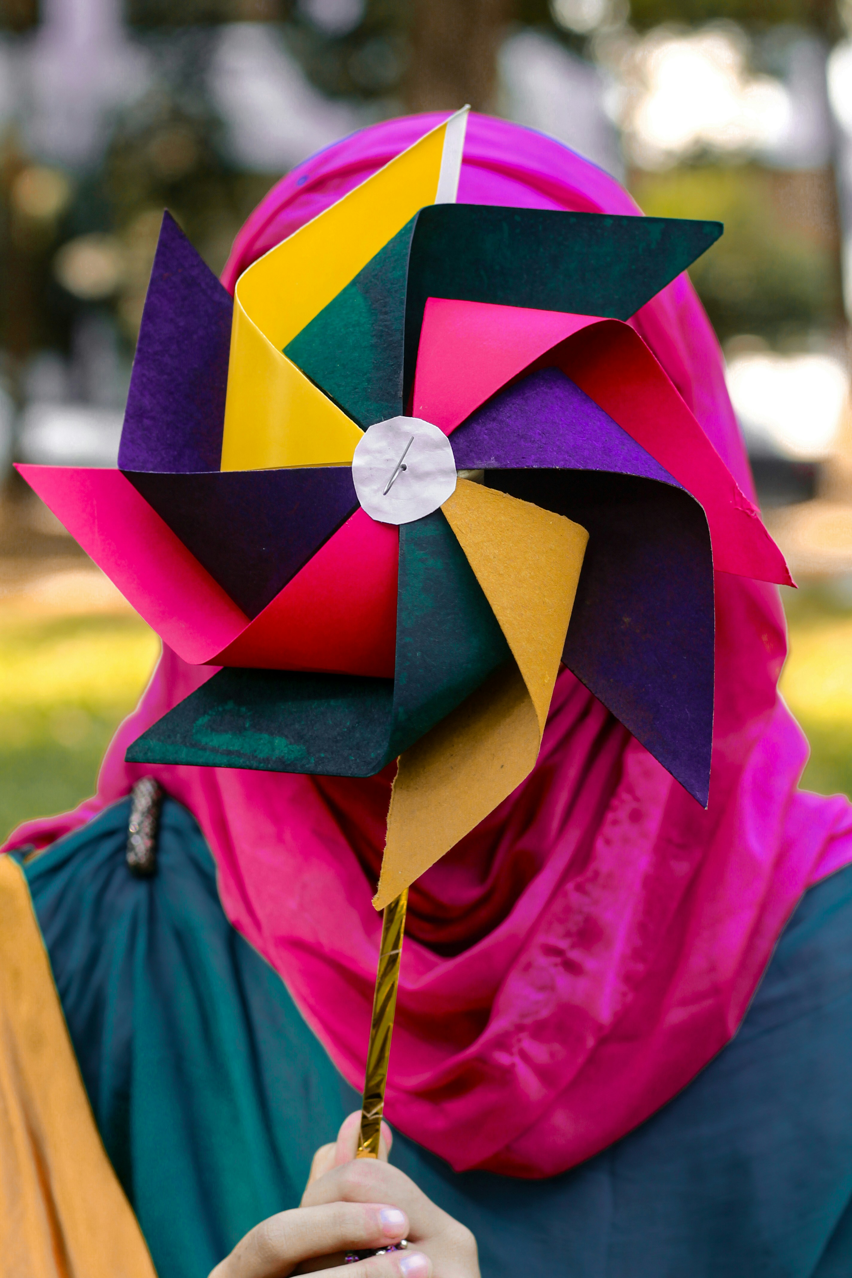 A woman wearing a colorful hat holding a pinwheel photo – Free Dhaka ...