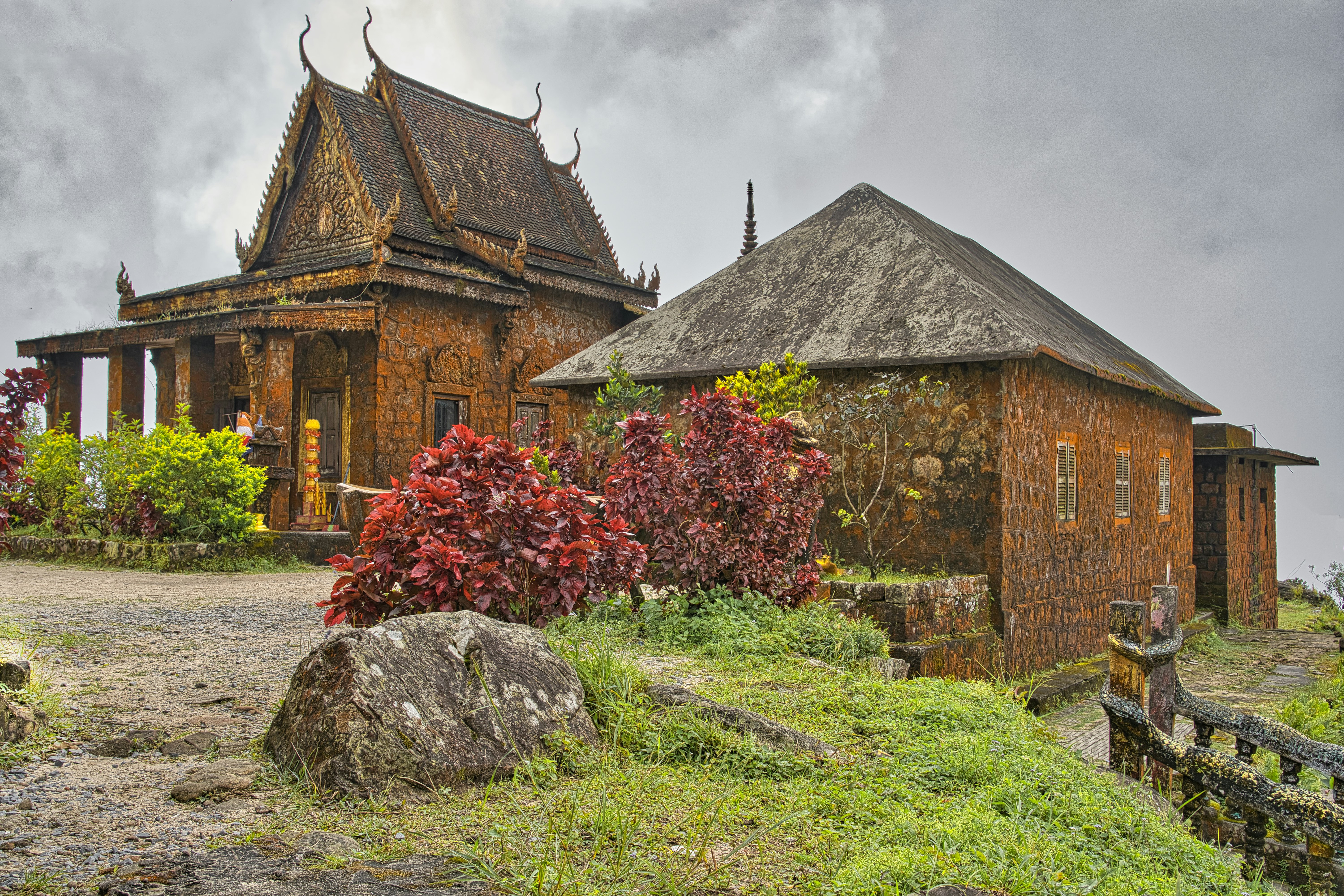 Temple on the Ridge: Weathered Stone, Crimson Foliage, and a Misty Sky
