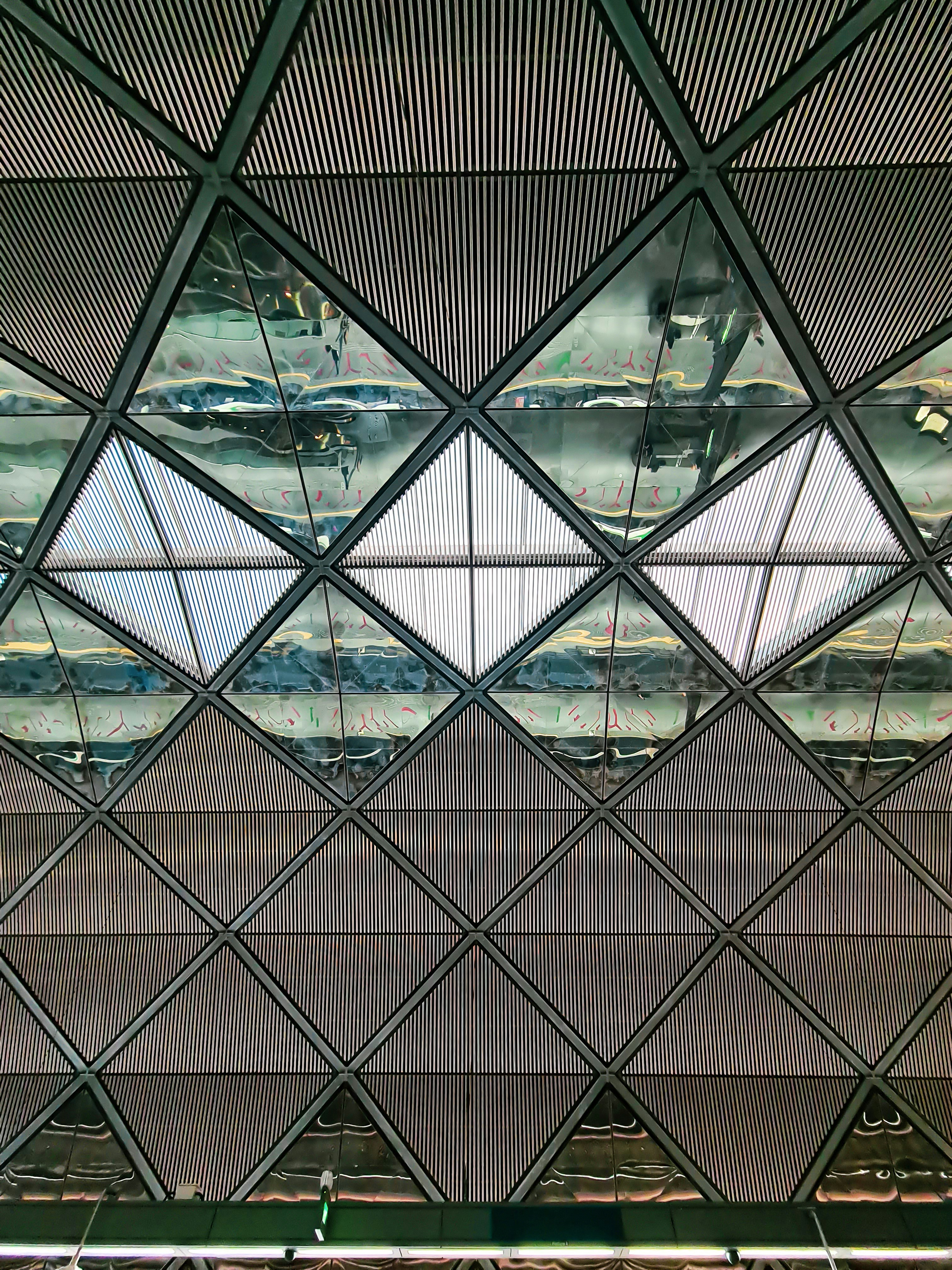 Diamond Grid Reflections: A Glass Roof's Geometric Tapestry
