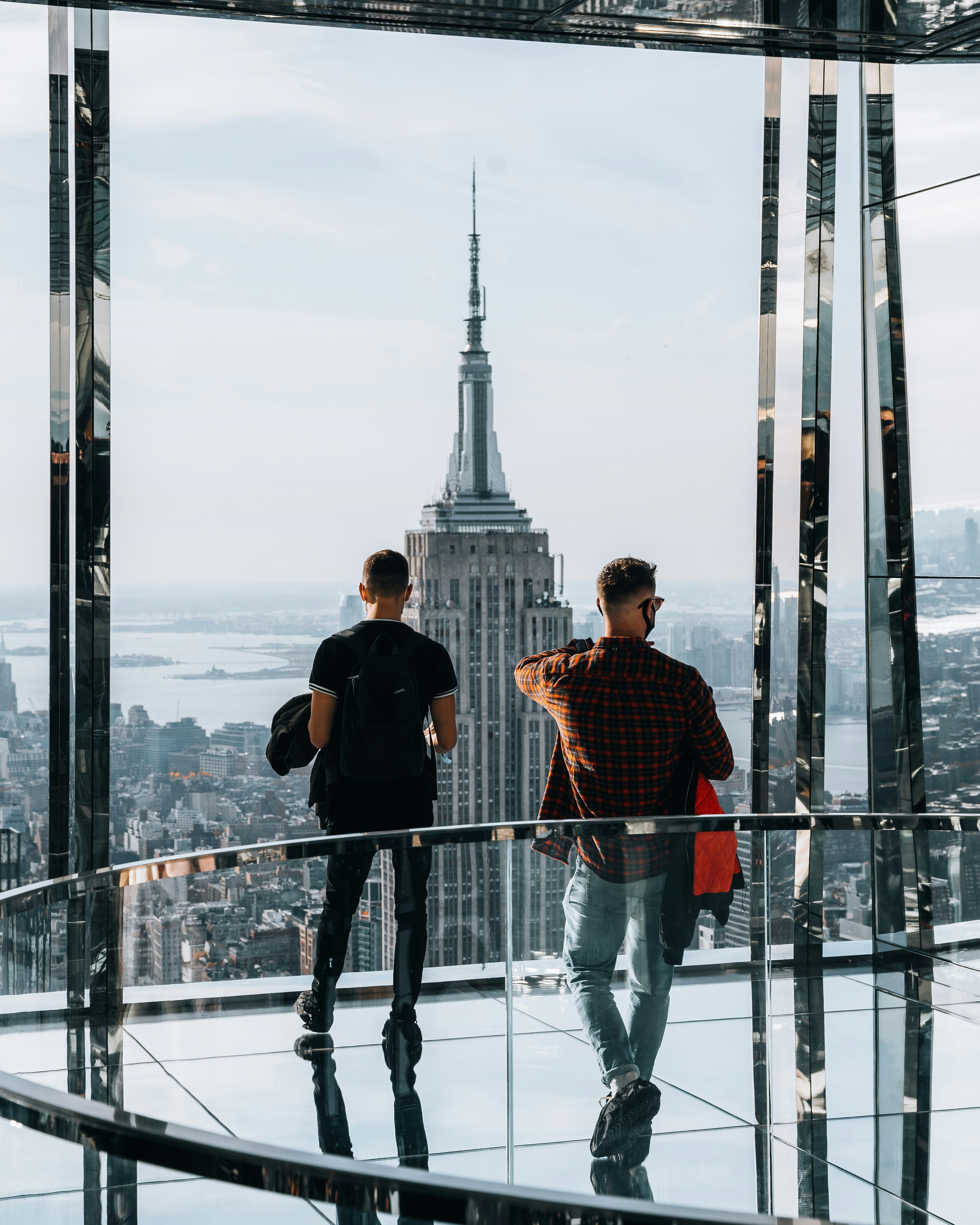 Two men standing on top of a tall building photo – Free Iphone ...