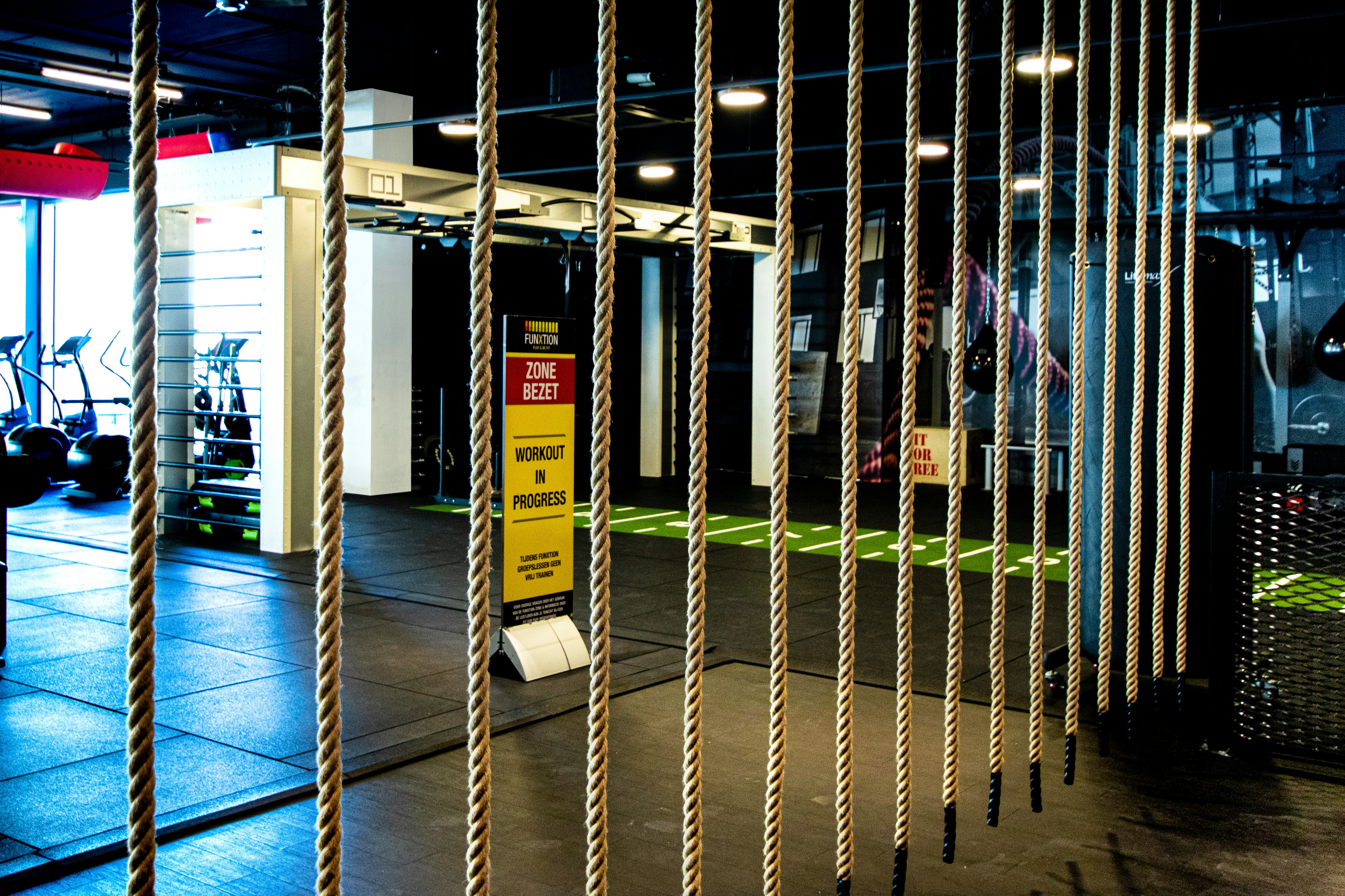 A gym with ropes hanging from the ceiling photo – Free Rotterdam ...