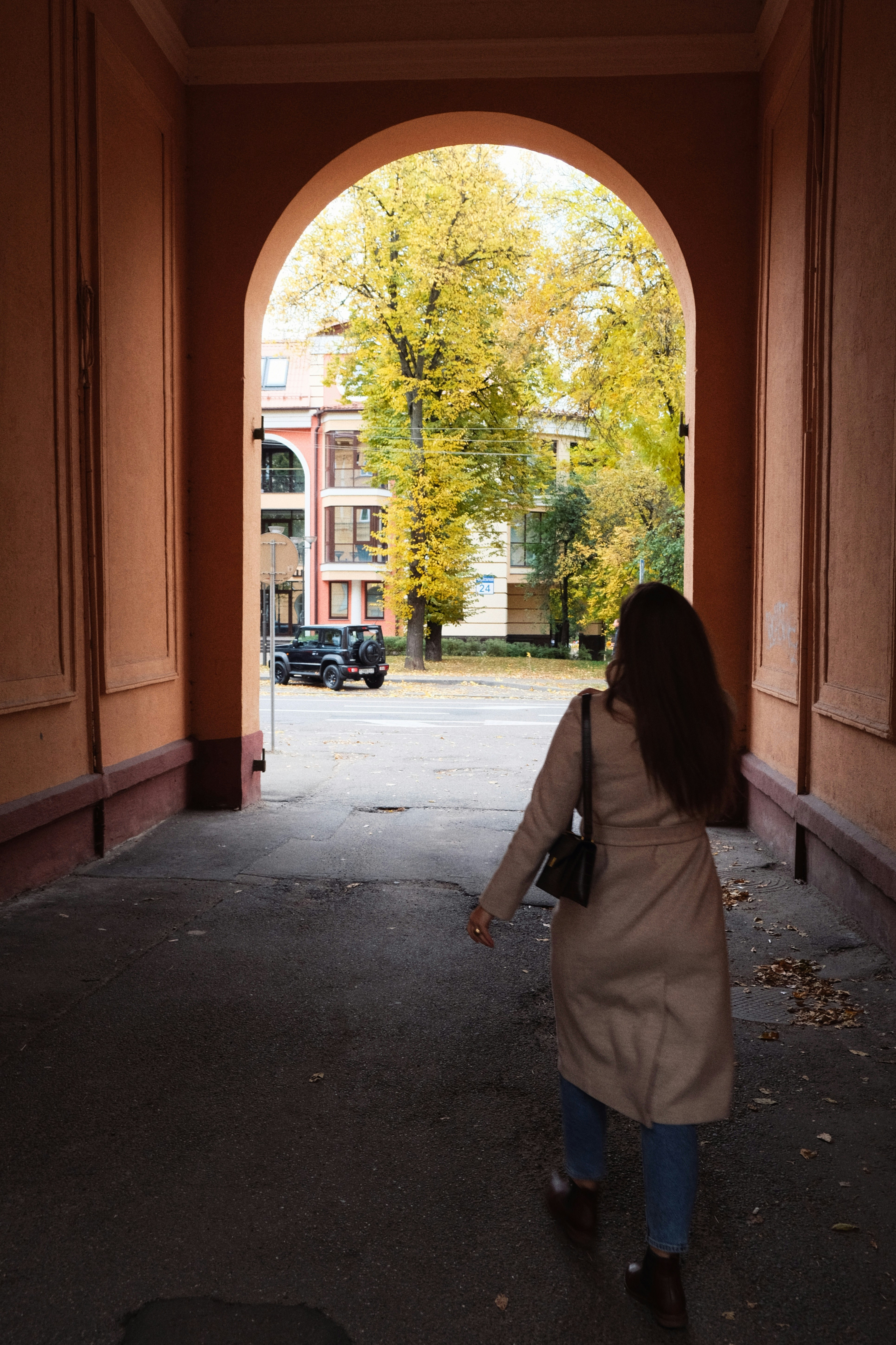 Arched Corridor to a Sunlit Fall Street
