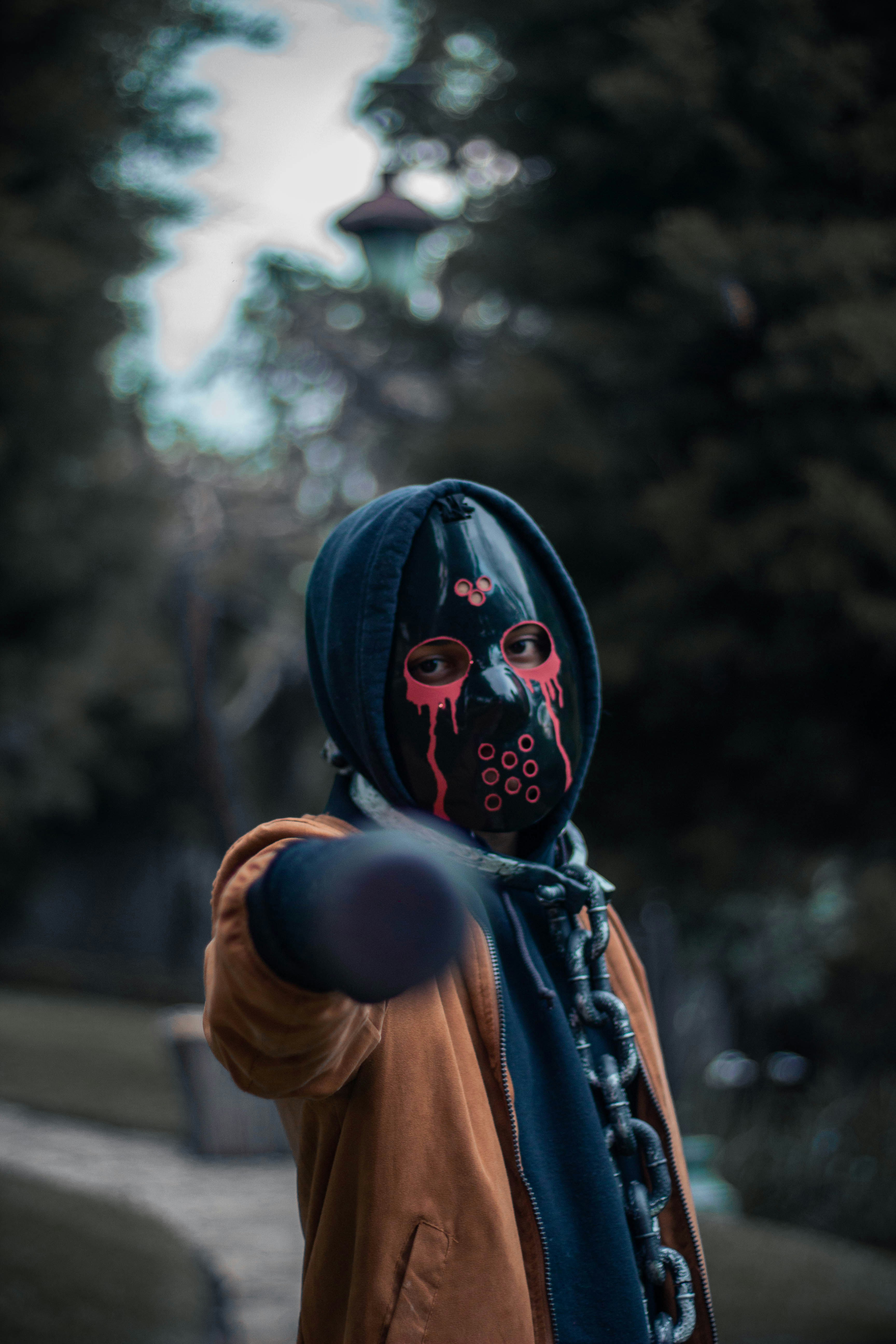 A person wearing a mask throwing a frisbee photo – Free Halloween Image ...