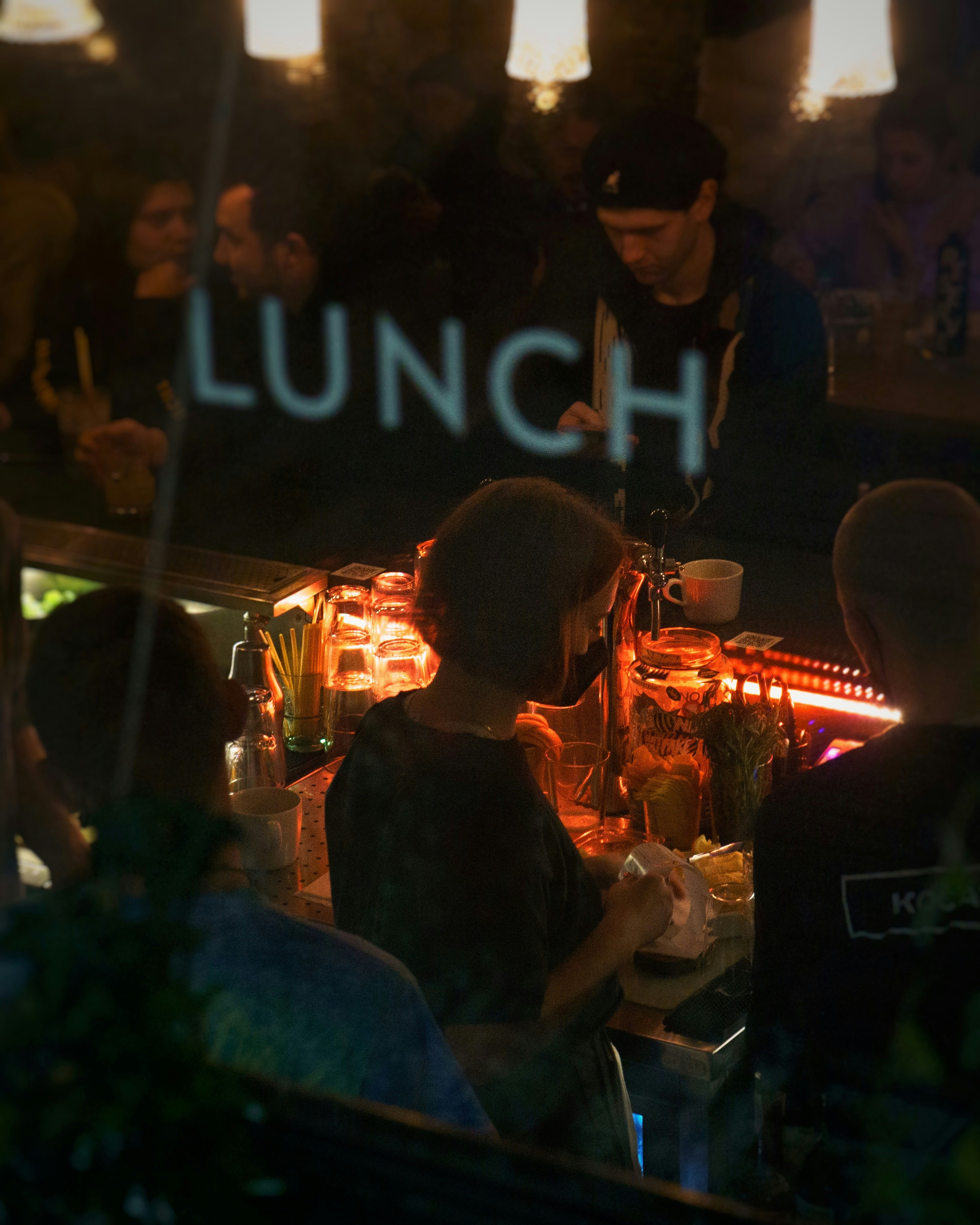 Midnight Glow at the Bar: Faces in Motion Under Neon Glass