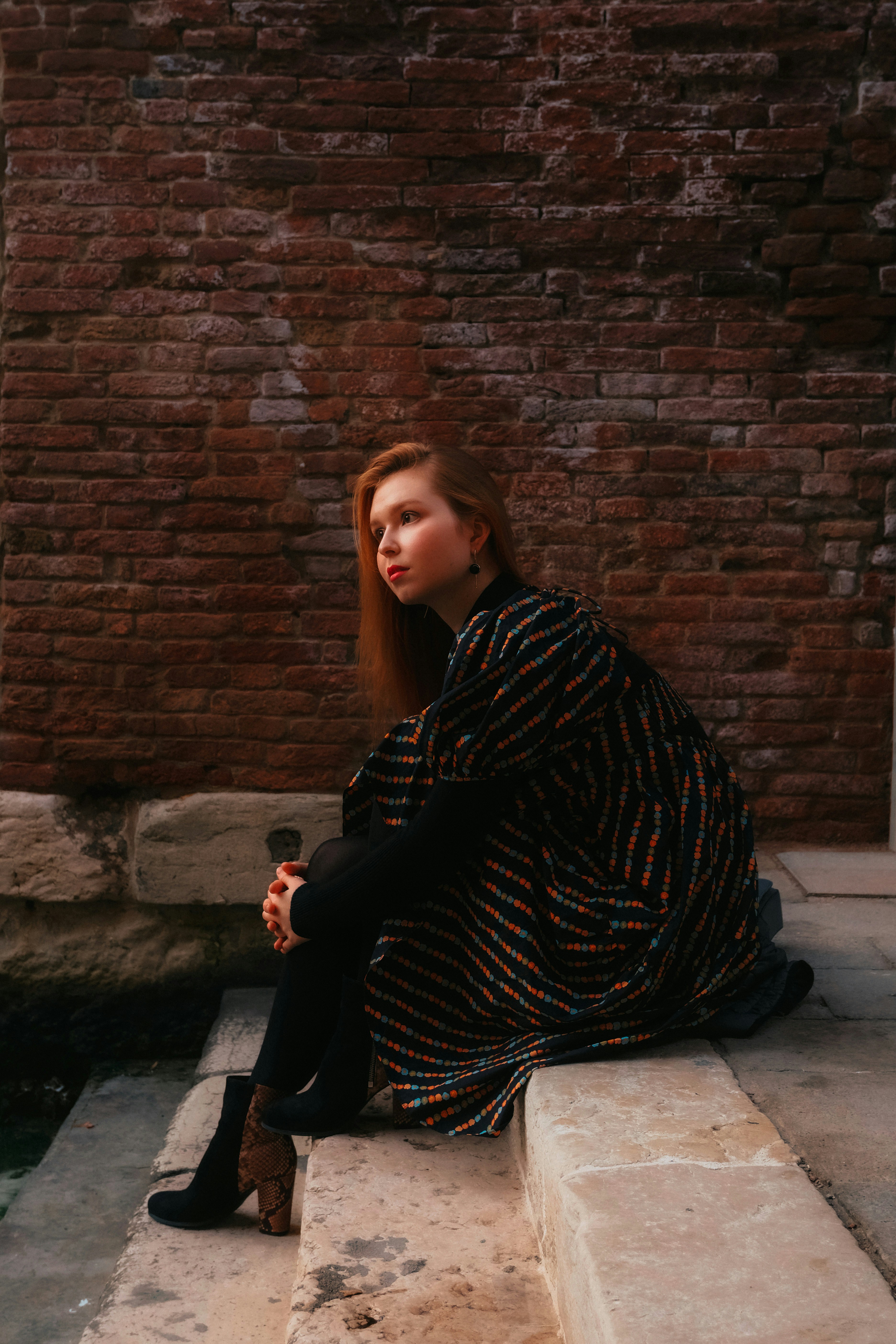 Weathered Brick, Quiet Pose: Portrait on Stone Steps