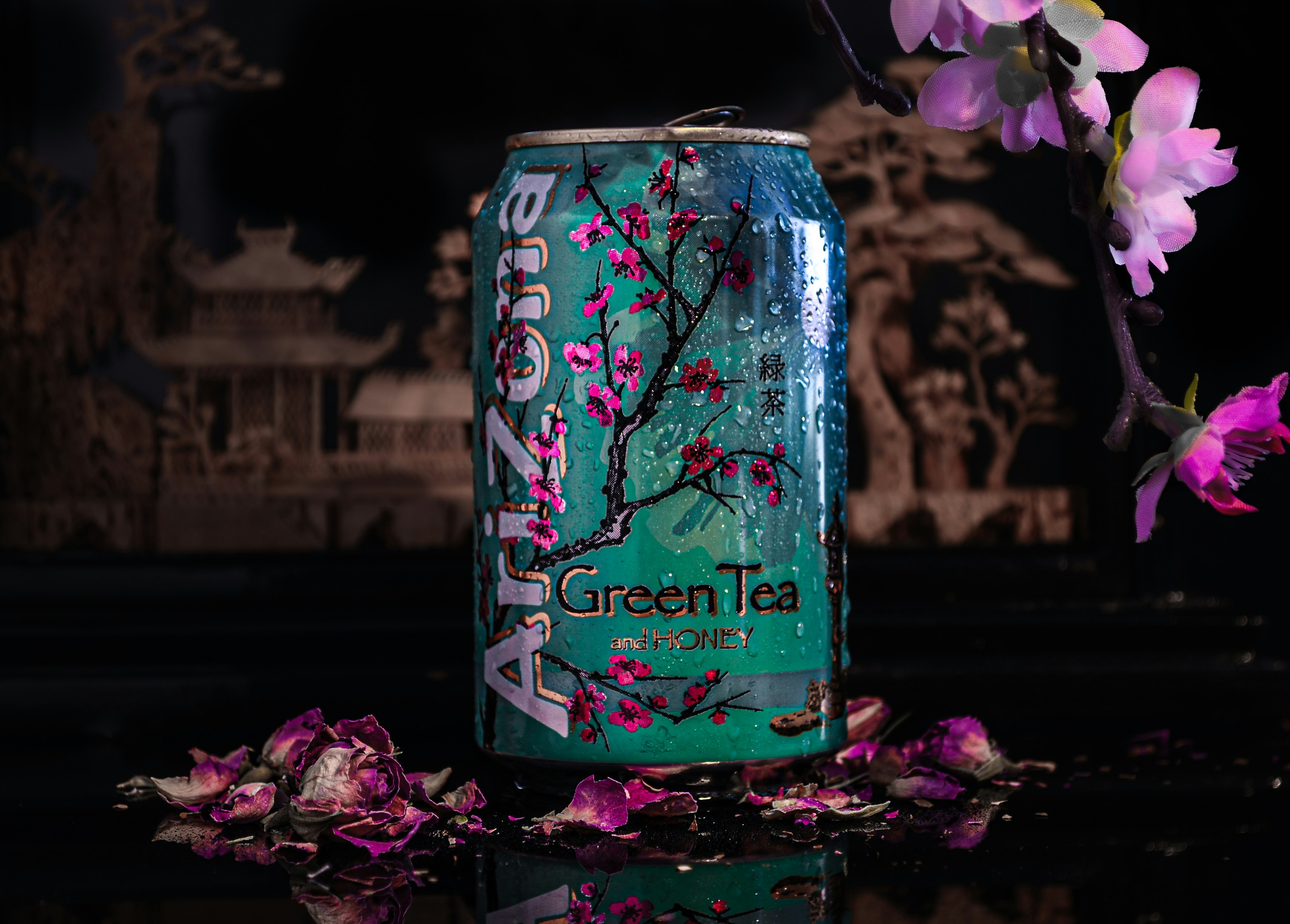 Arizona Green Tea in Bloom: Teal Can with Pink Petals in a Velvet Backdrop