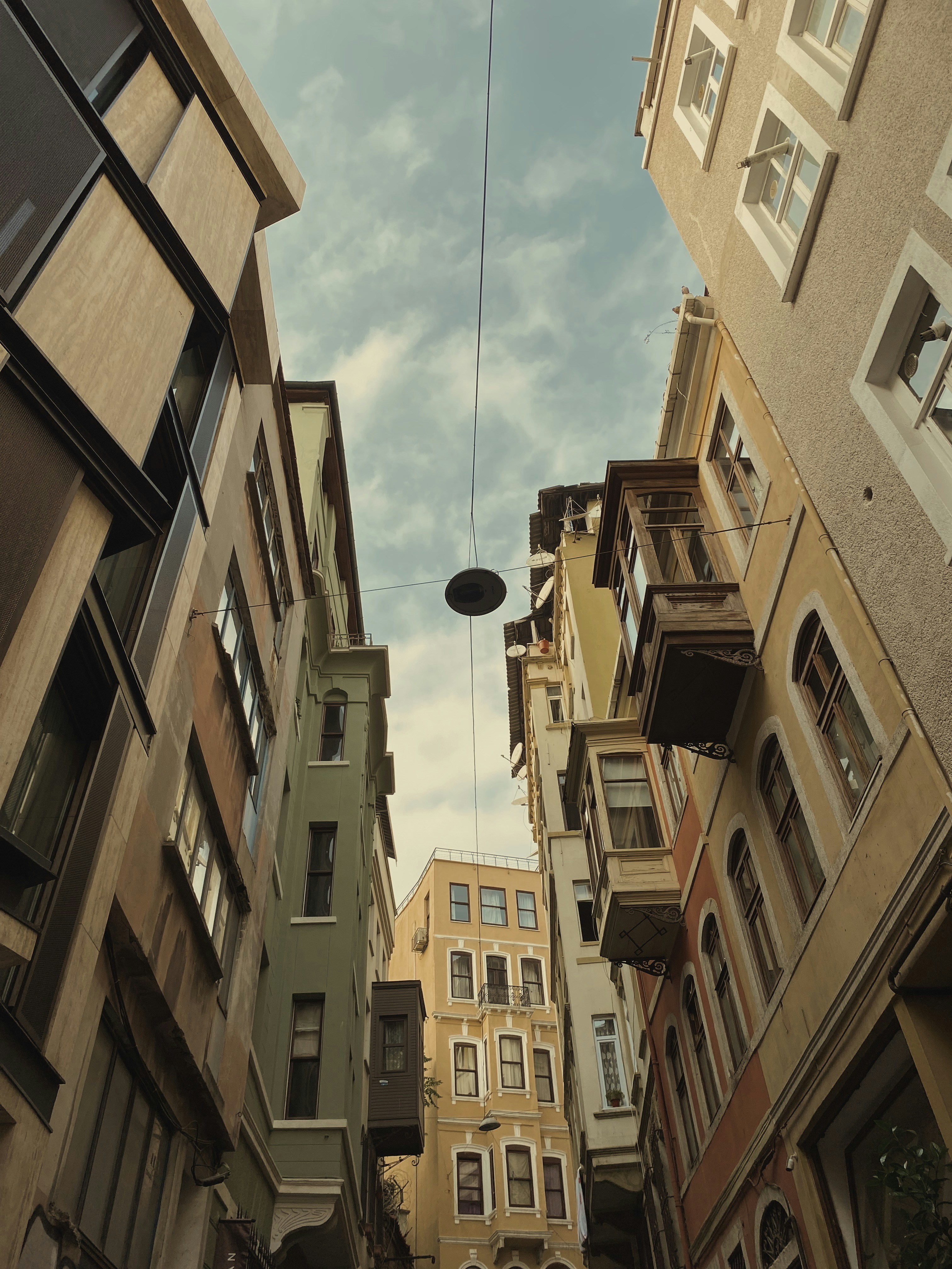 A street light hanging from a wire between two buildings photo – Free ...