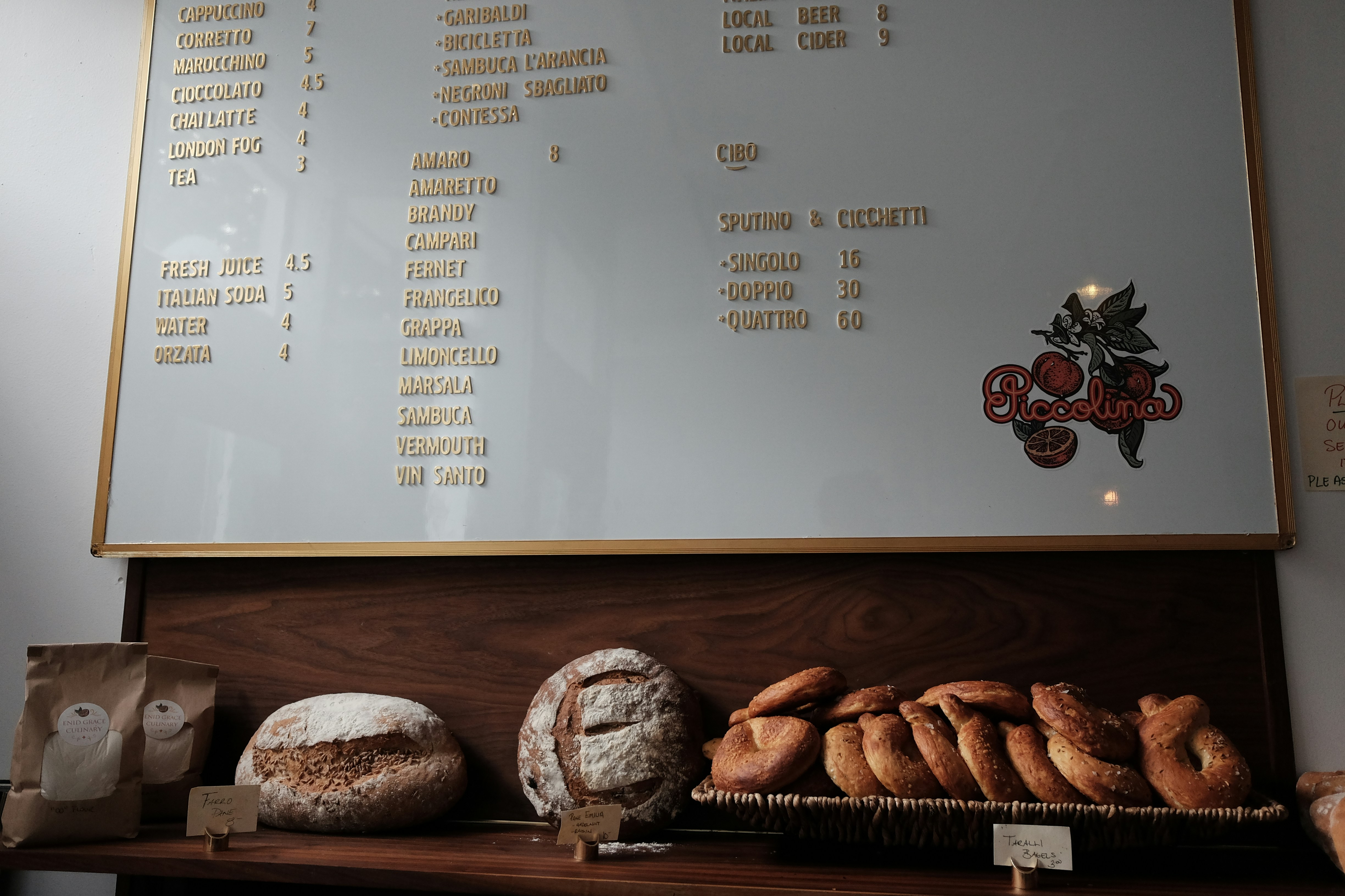 Rustic Bakery Display: Crusty Loaves and Pastries on a Wooden Shelf