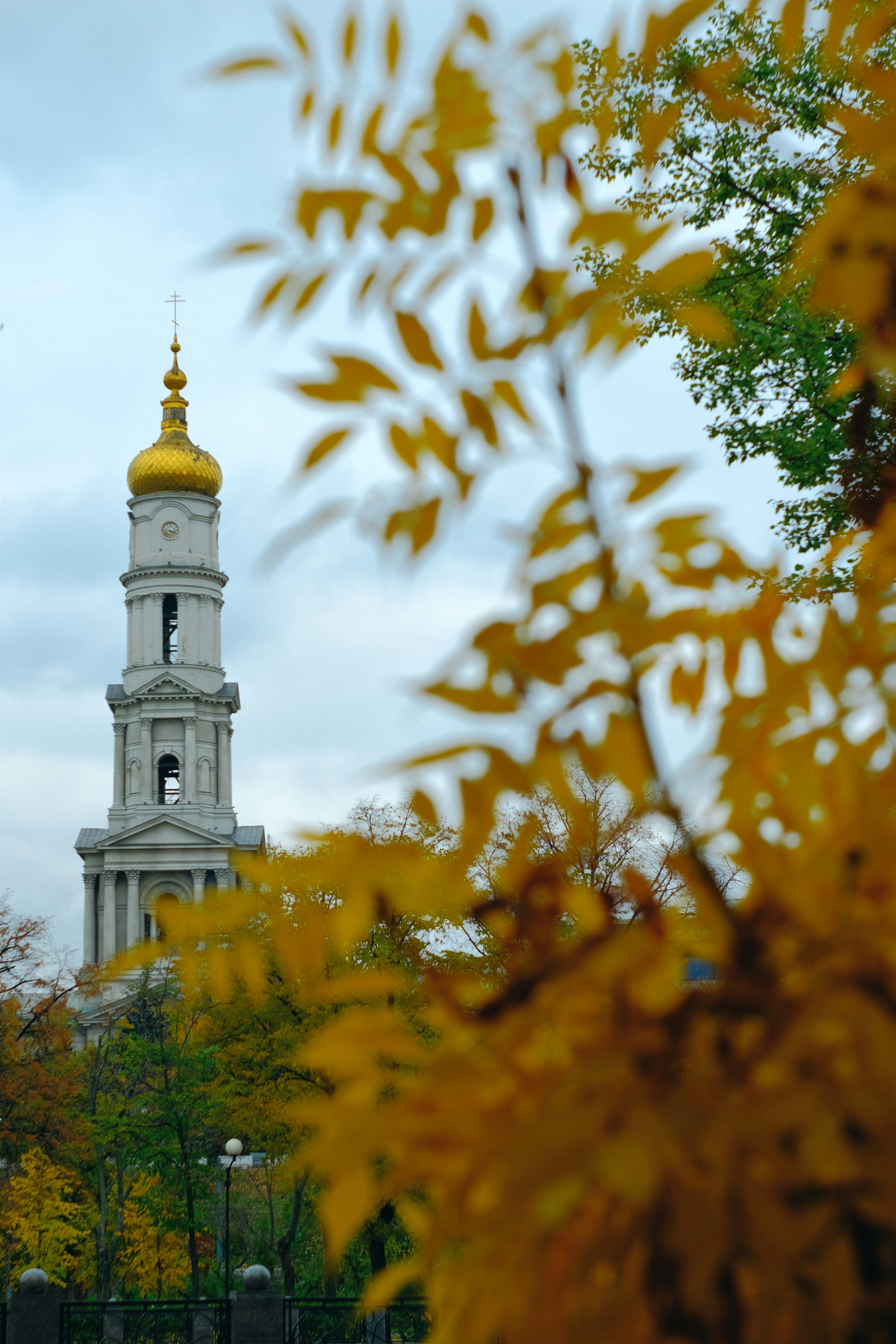 a tall white building with a golden dome