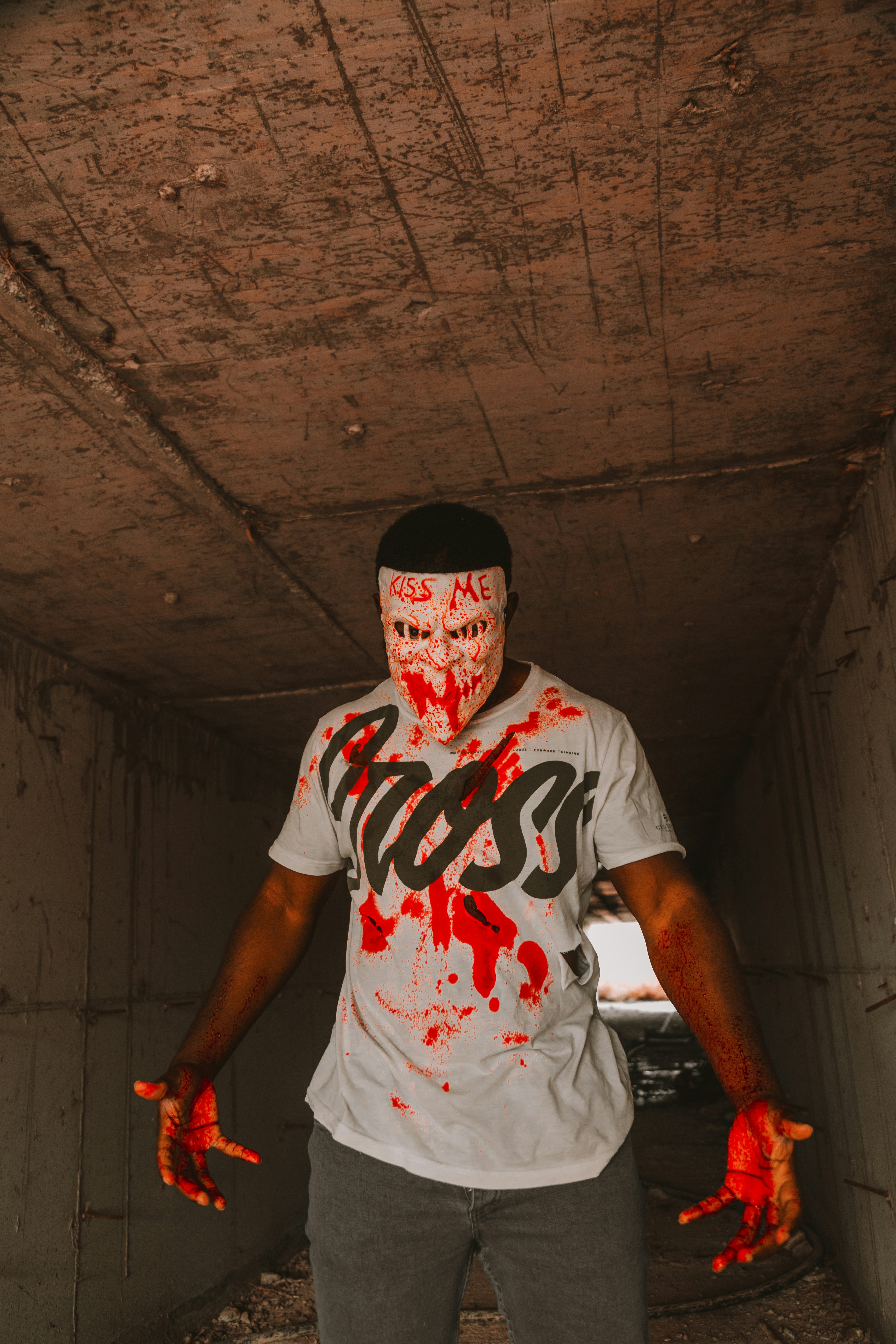 Bloodied Masked Figure Emerging in Dim Underpass
