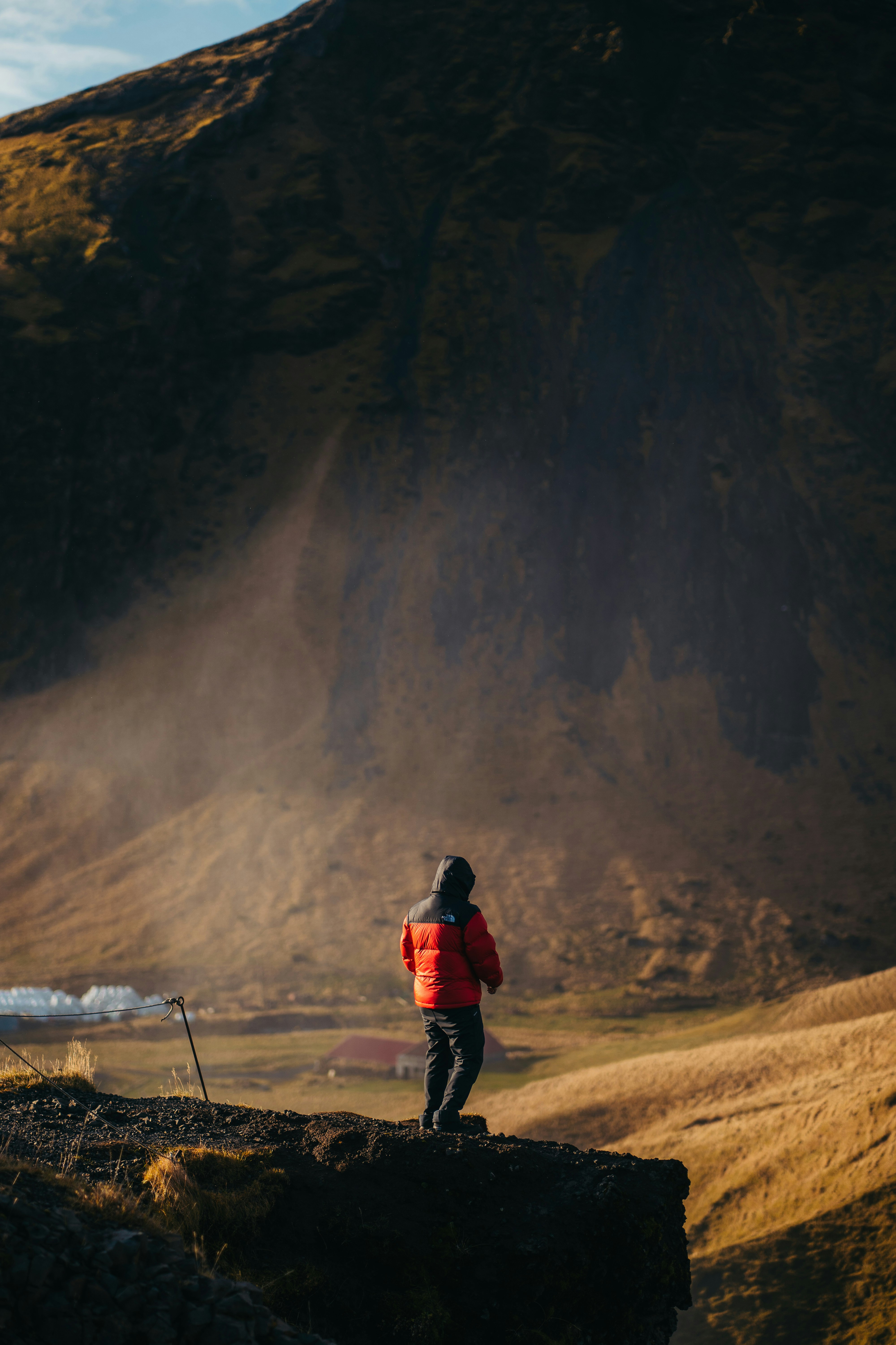 On the Edge of Silence: A Red Jacket against the Mountain Mist