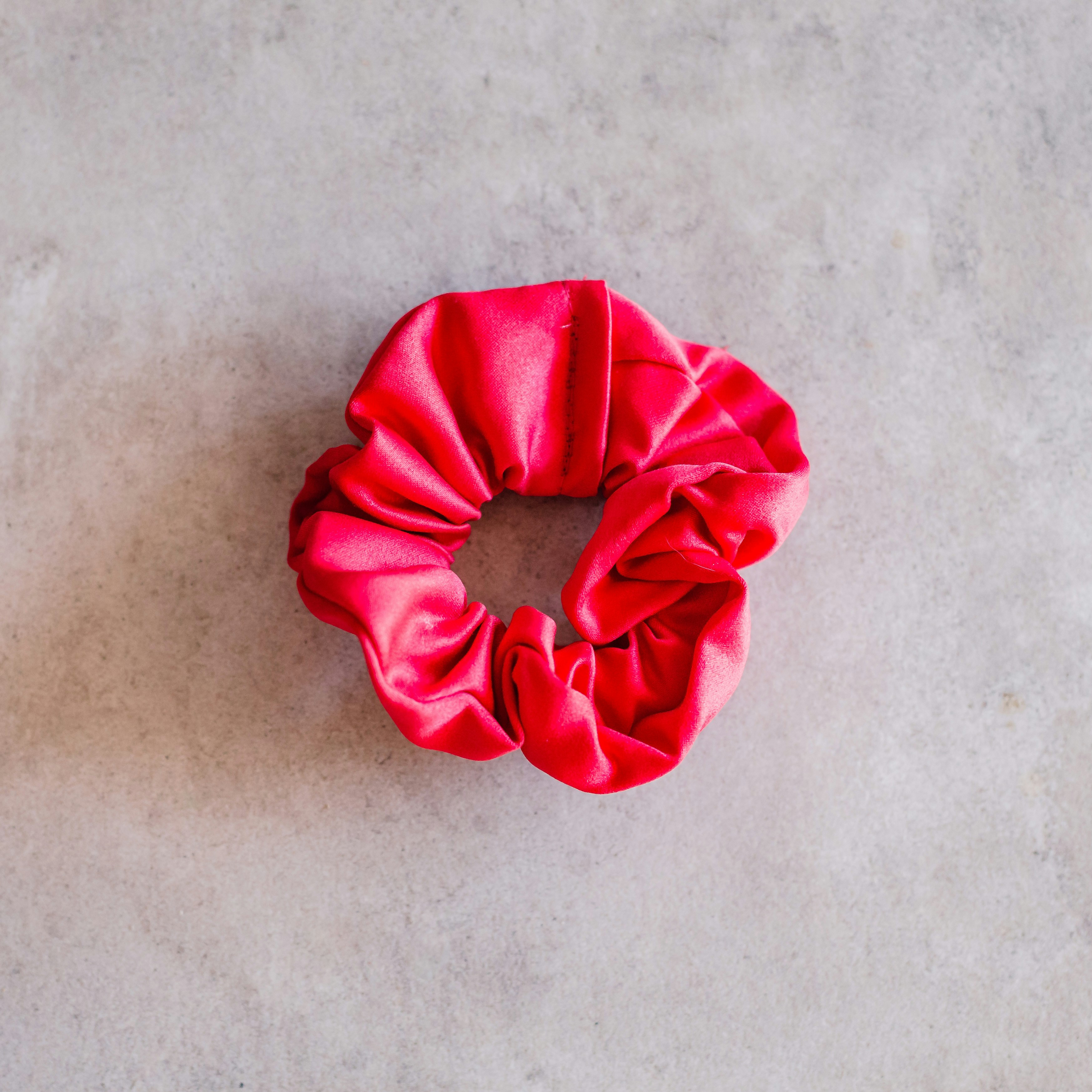 A red scrunchy hair scrunch on a gray surface photo – Free Red Image on ...