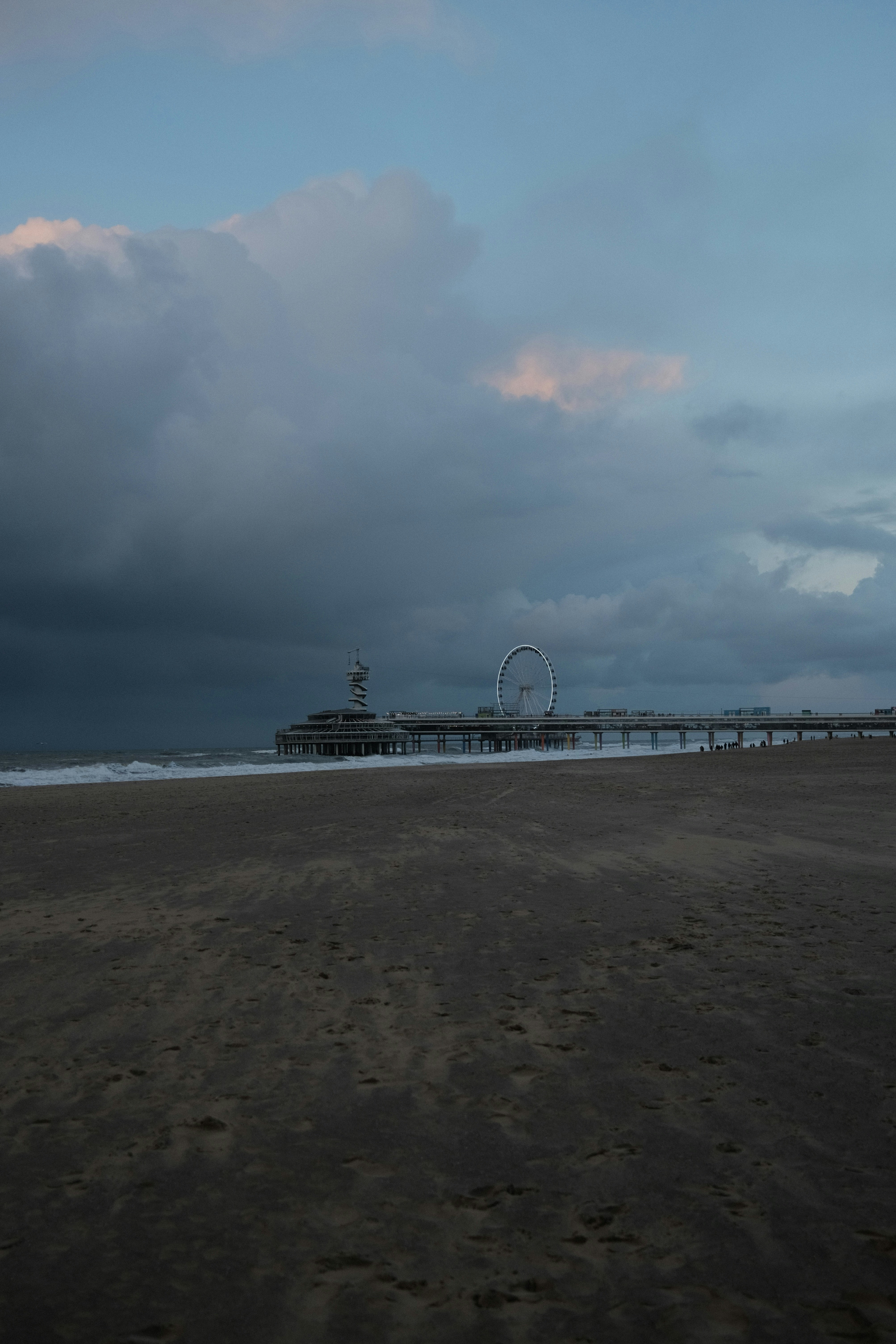 Edge of the Sea: The Pier, a Ferris Wheel, and a Moody Sky