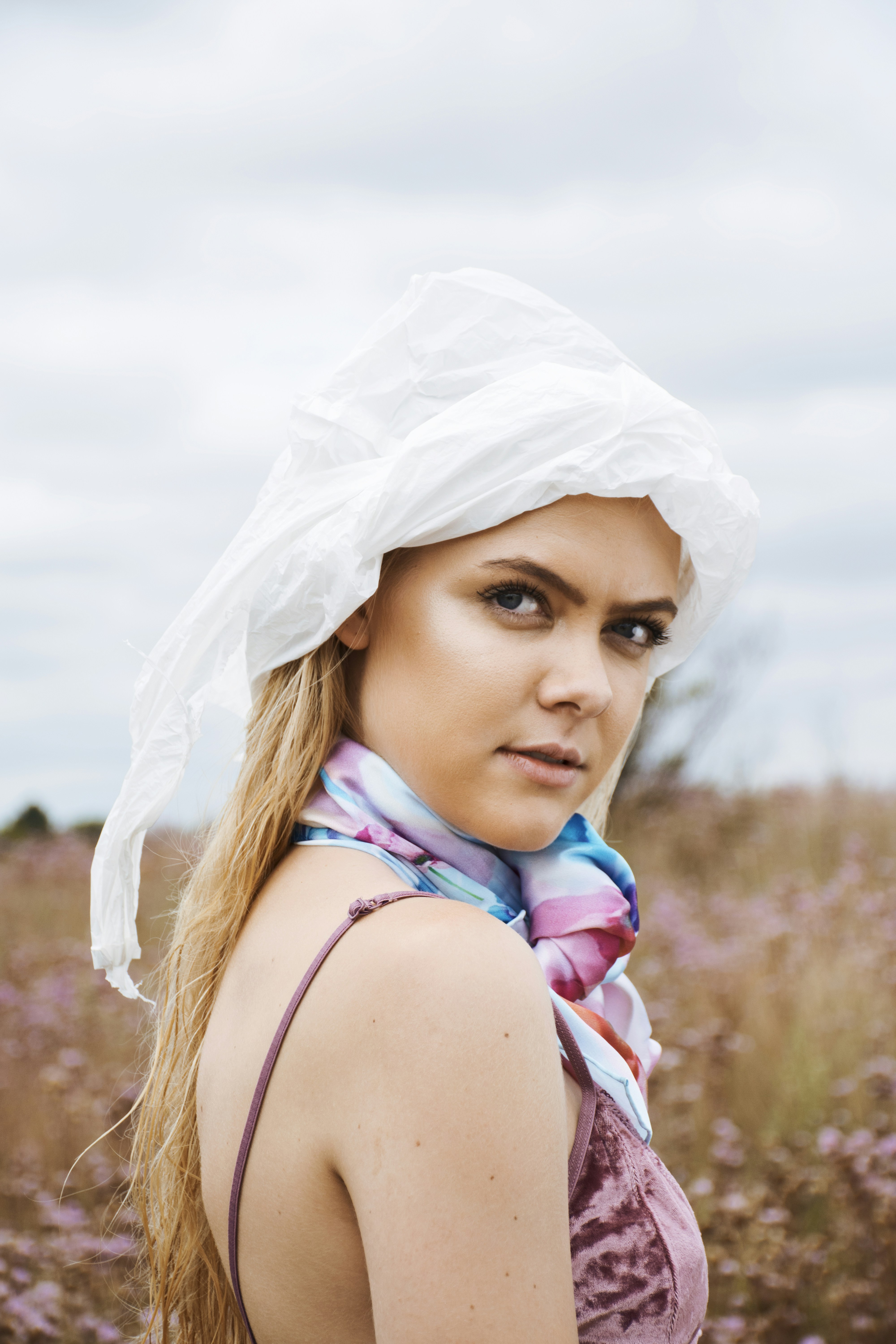 Gaze in the Wind: Silk-Scarved Portrait Among Blush Wildflowers