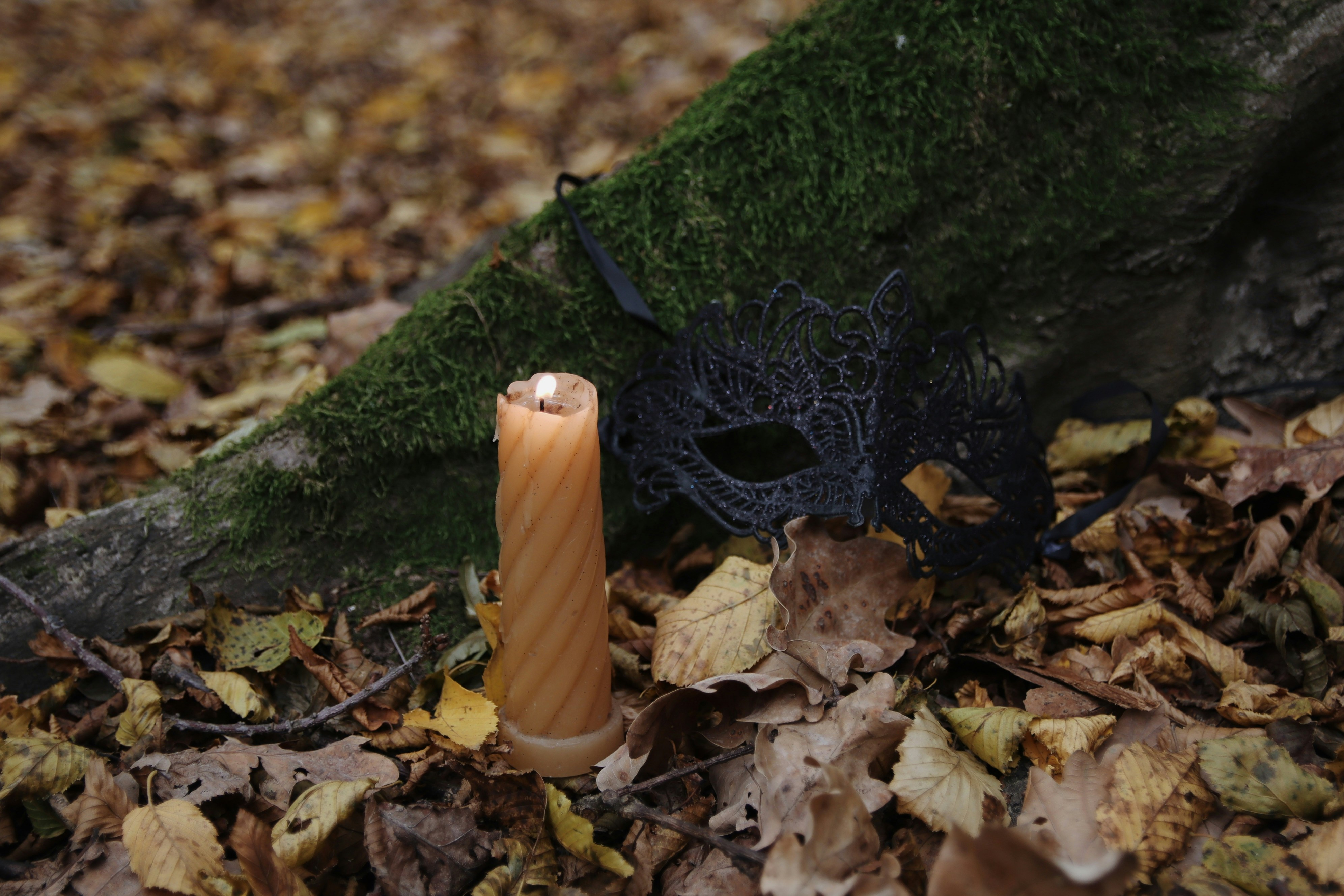 A candle and a mask on the ground photo – Free Mask Image on Unsplash