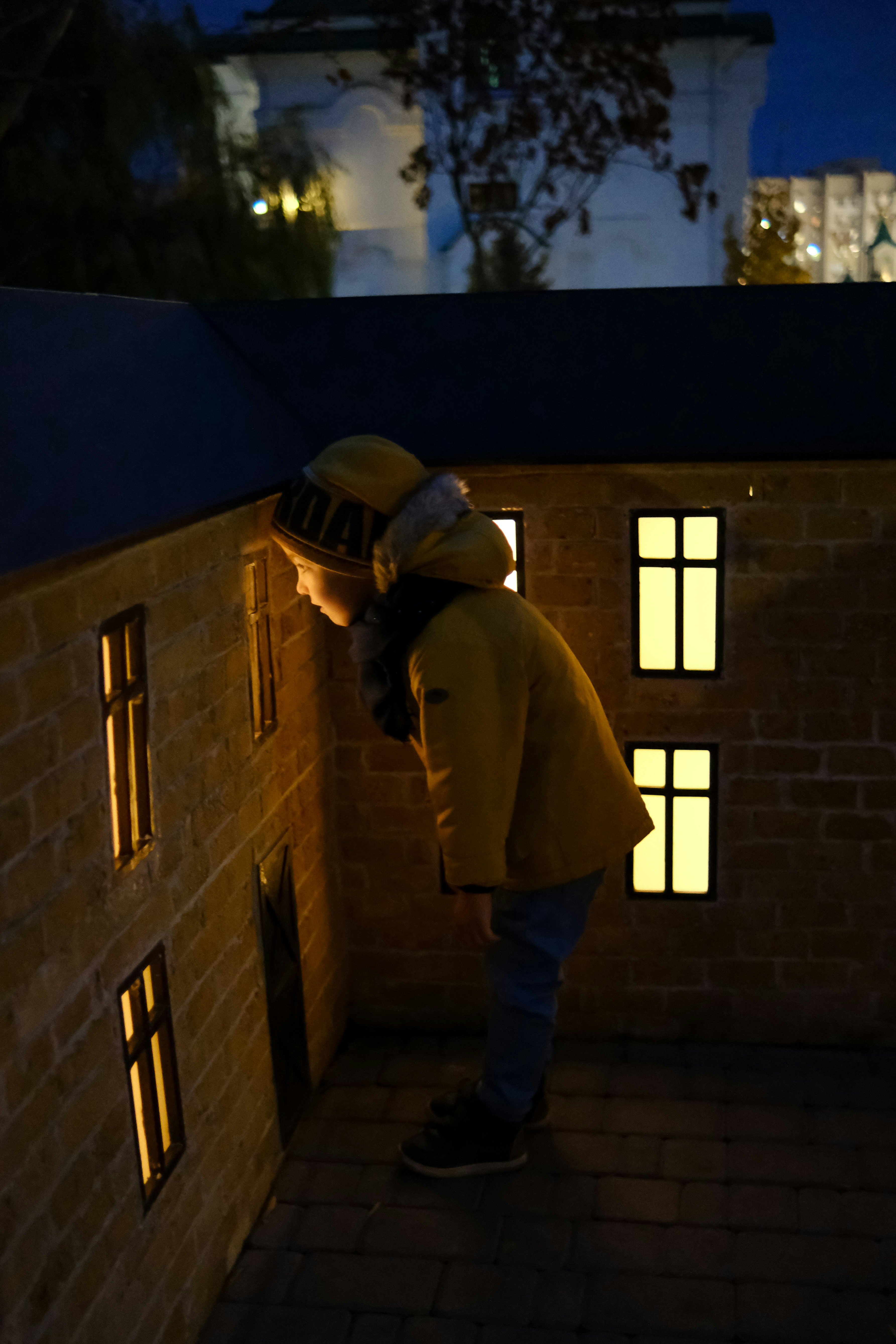 A person standing outside of a building at night photo – Free Human ...