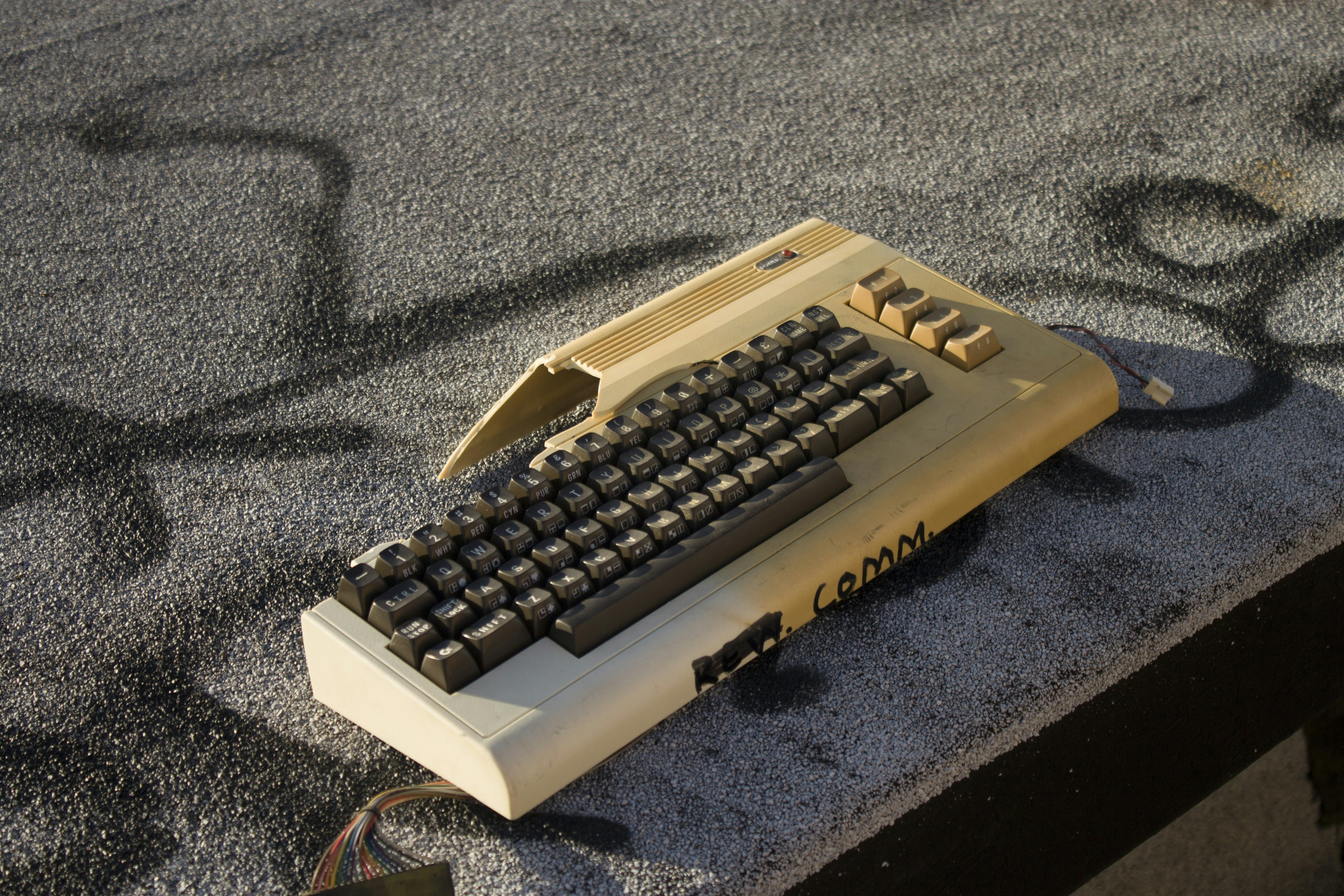 A computer keyboard sitting on top of a cement slab photo – Free ...