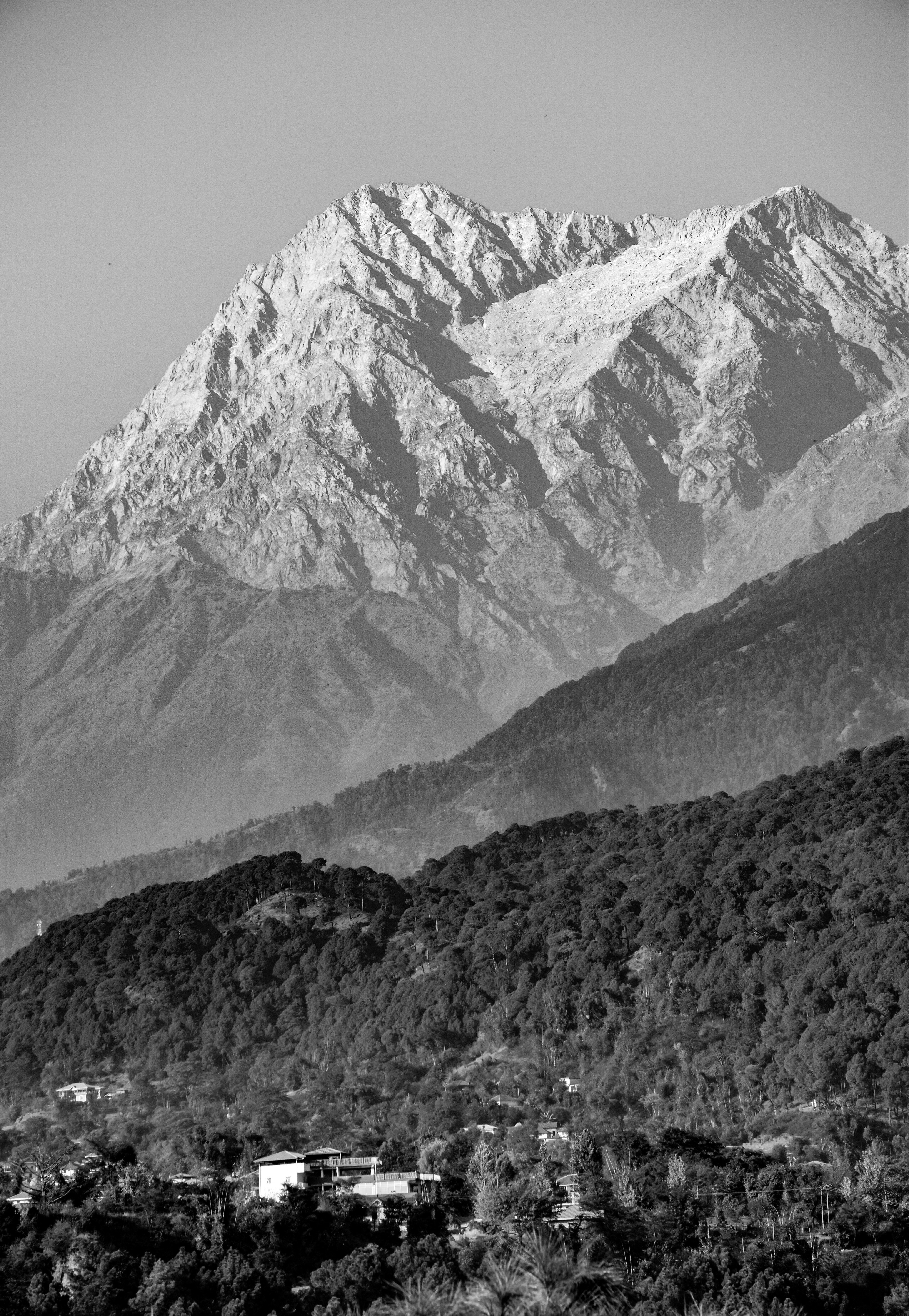Snow-creased Giants: A Himalayan Peak Over a Quiet Valley