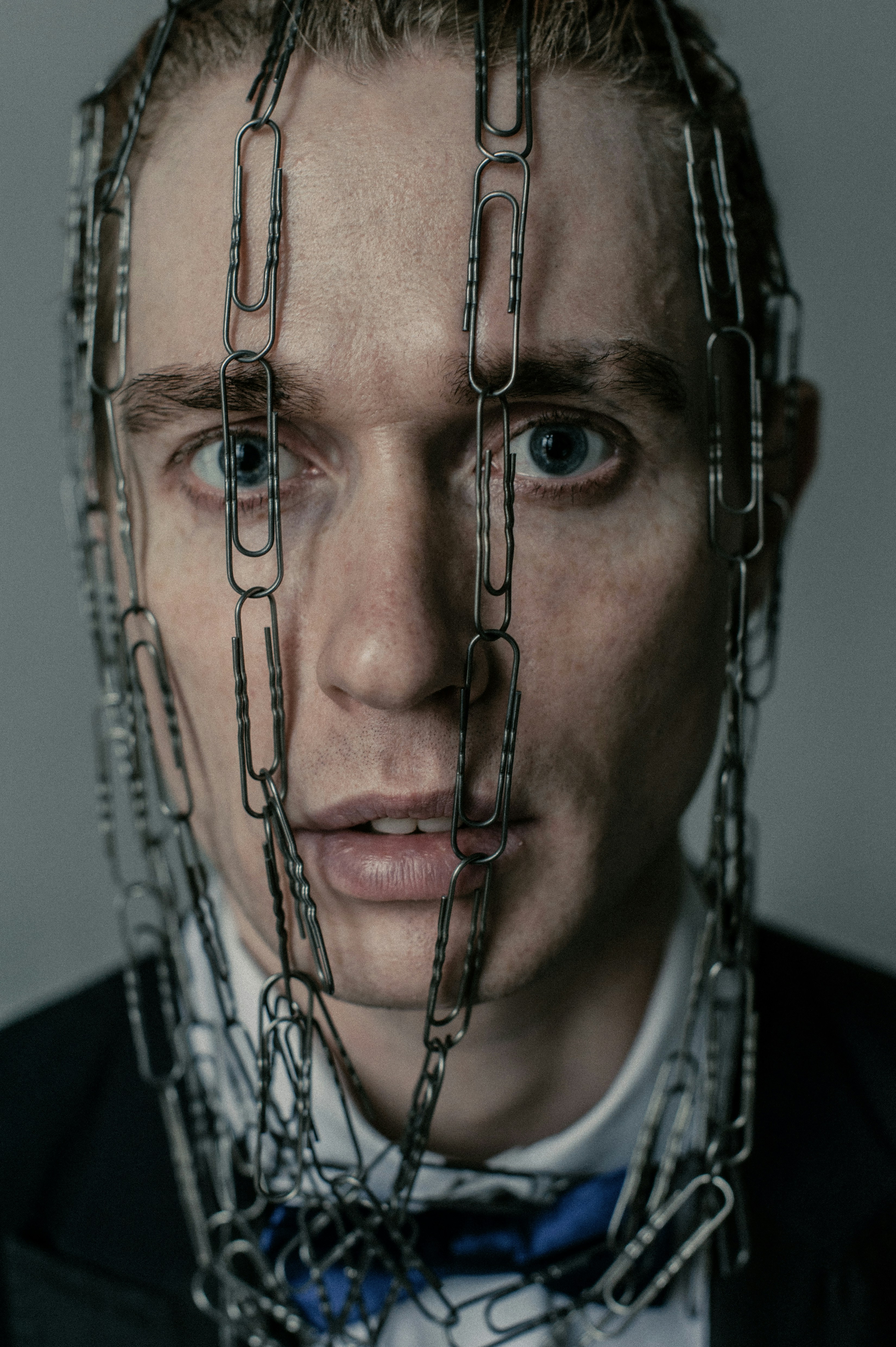 A man wearing a suit and tie with chains on his face photo – Free Art ...