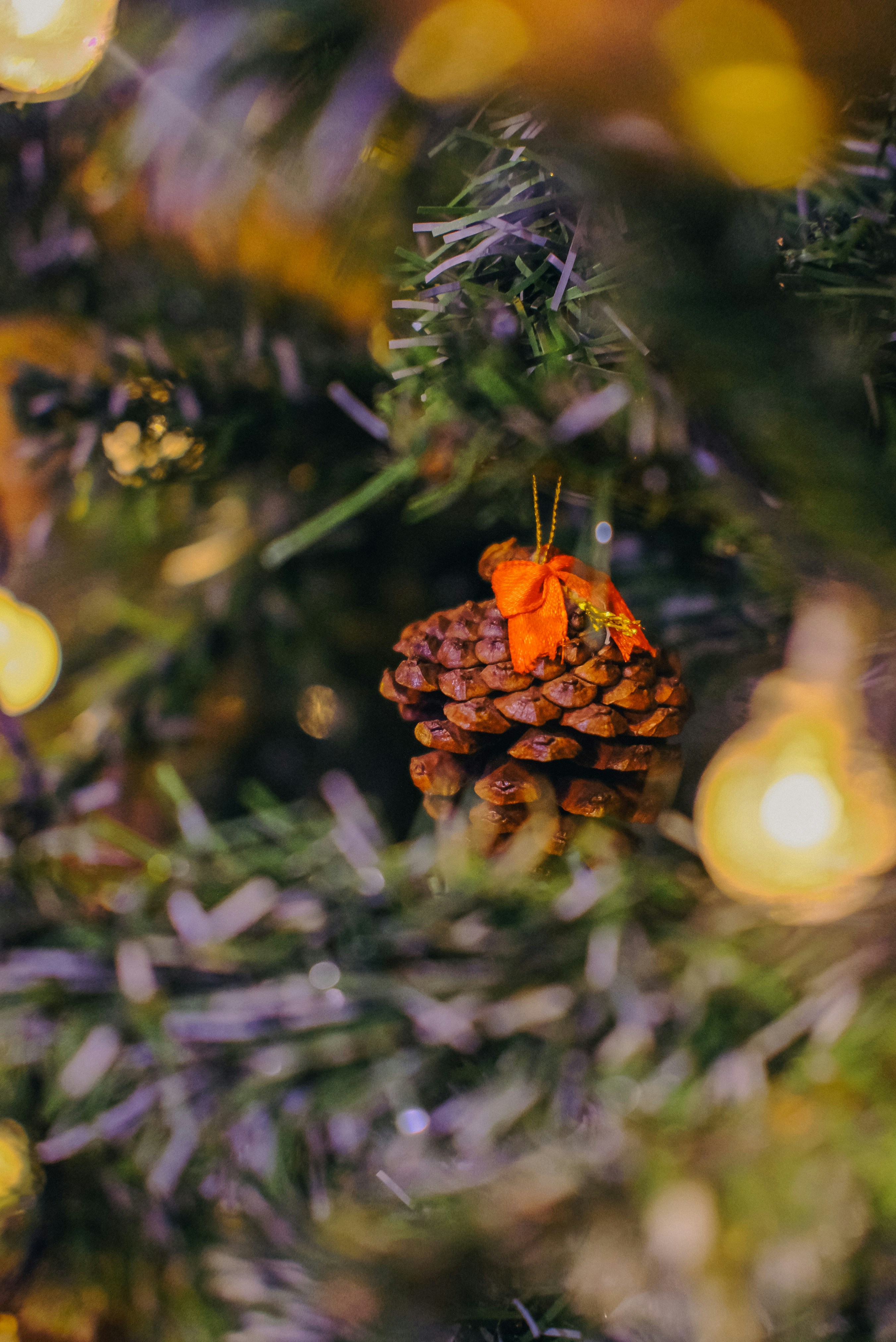 Caret weath of a pinecone ornament in a softly lit holiday scene