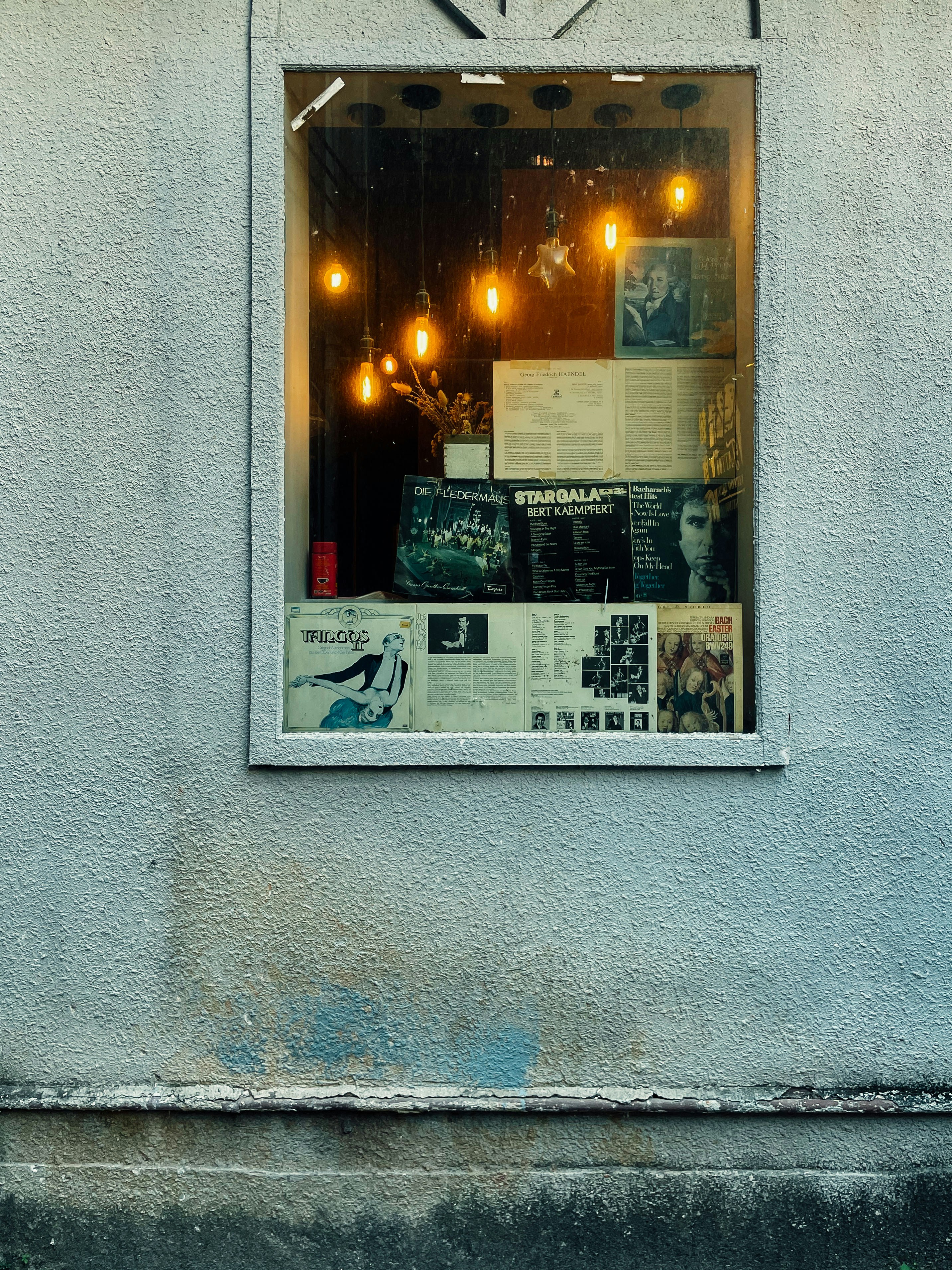 A window that has a bunch of posters in it photo – Free Advertisement ...