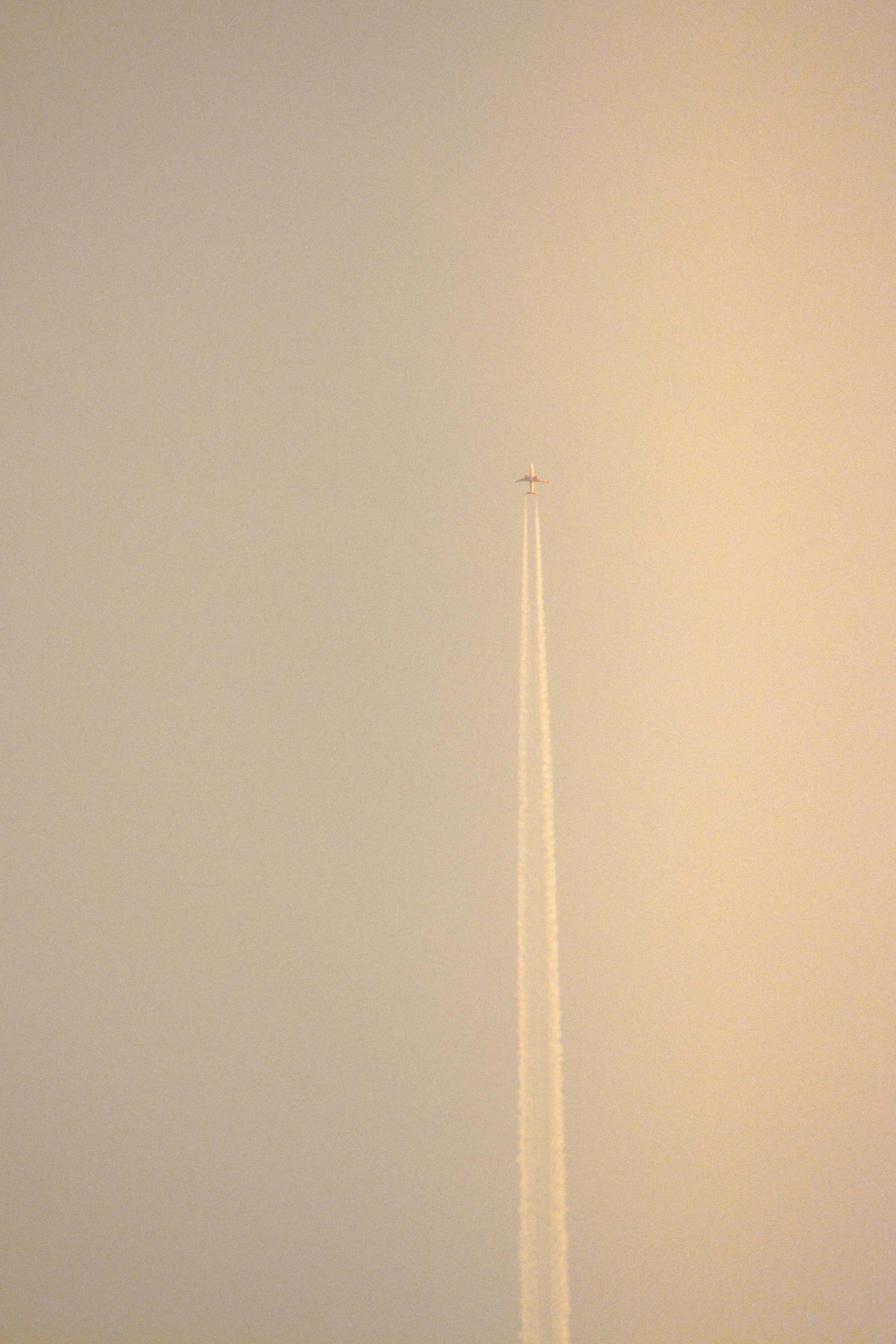 A plane flying in the sky with a trail of smoke behind it photo – Free ...