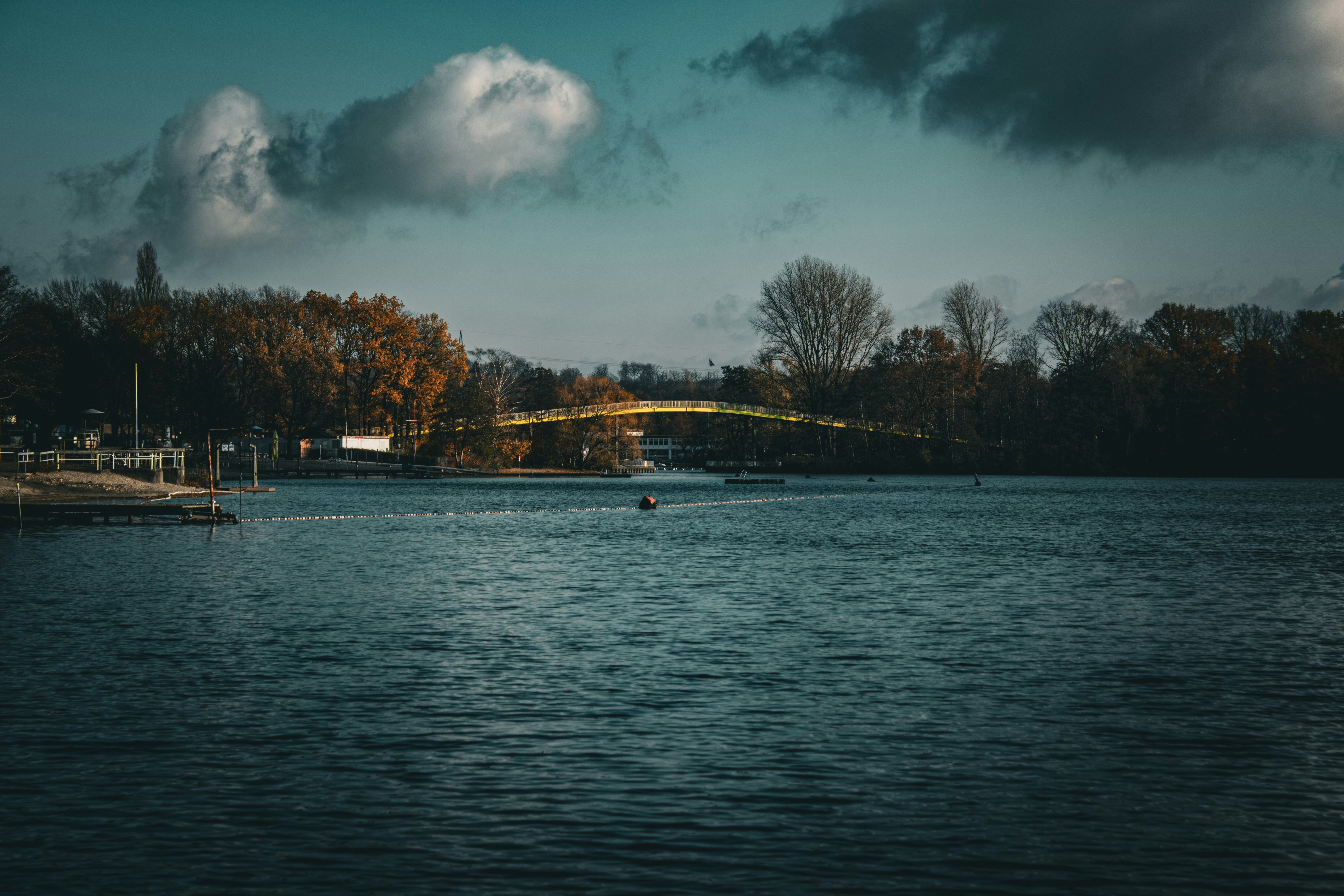 A yellow bridge over a lake