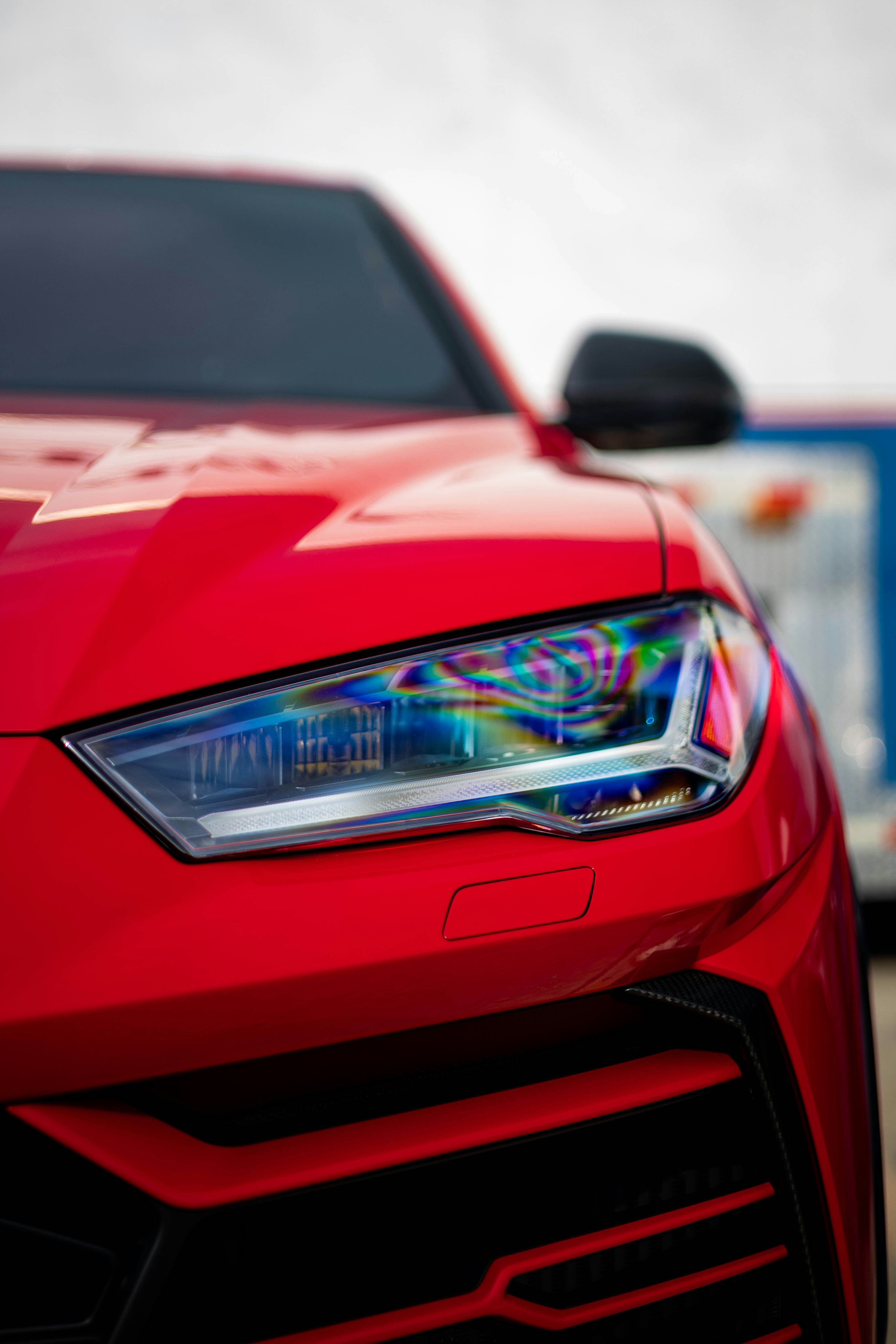 Crimson Frontline: Precision LED Portrait of a Red Sports Sedan