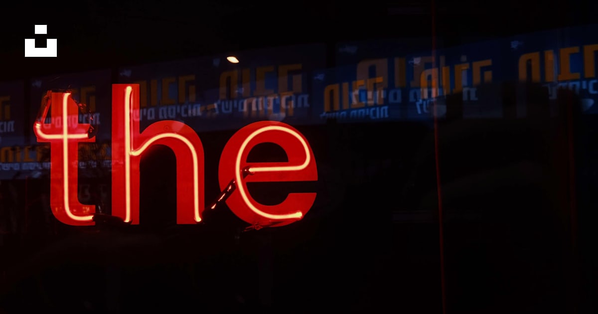 A Neon Sign That Says The On The Side Of A Building Photo Free