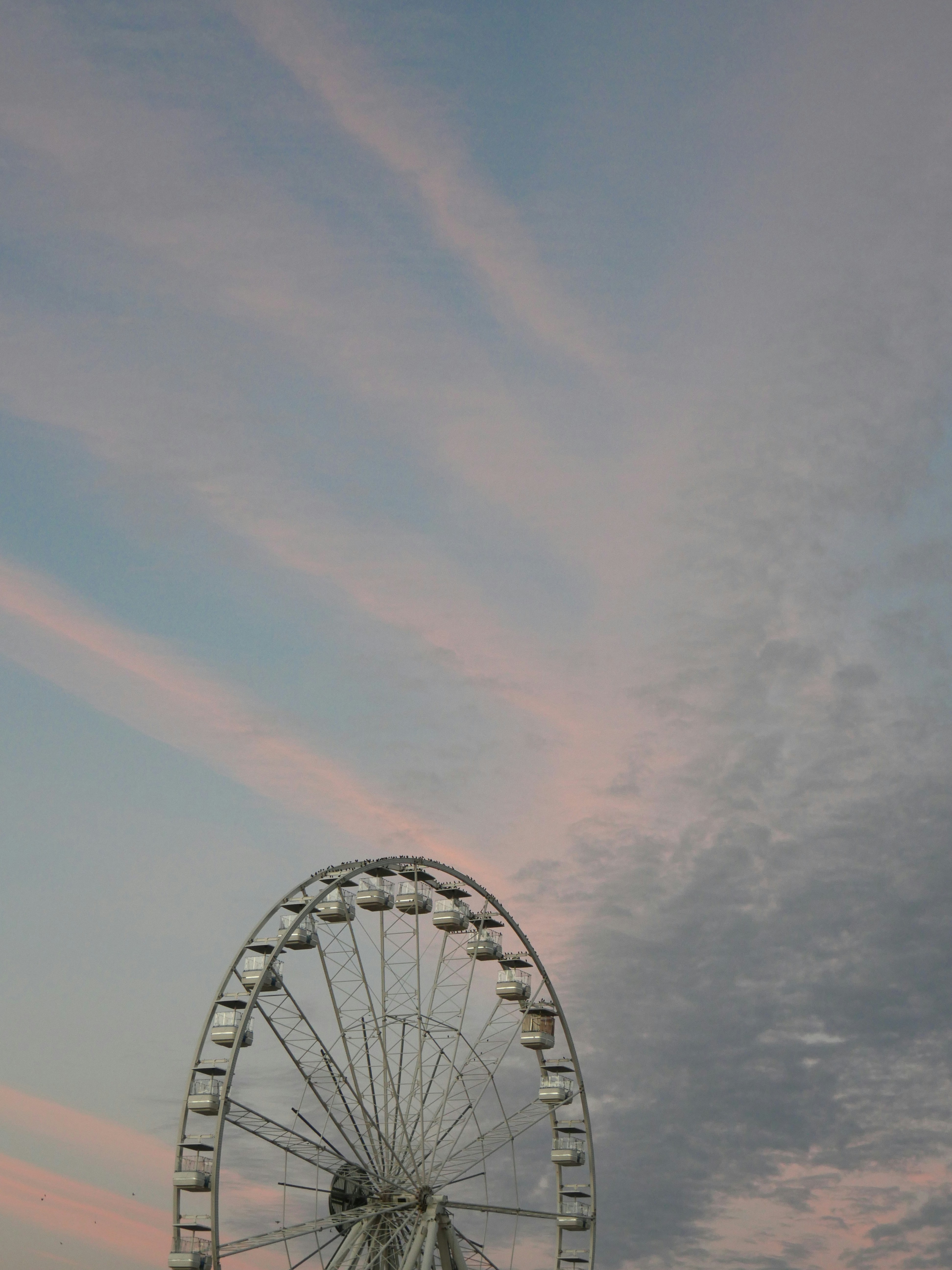 Pastel Sky and a Silent Giant: A Ferris Wheel Hugs the Dusk