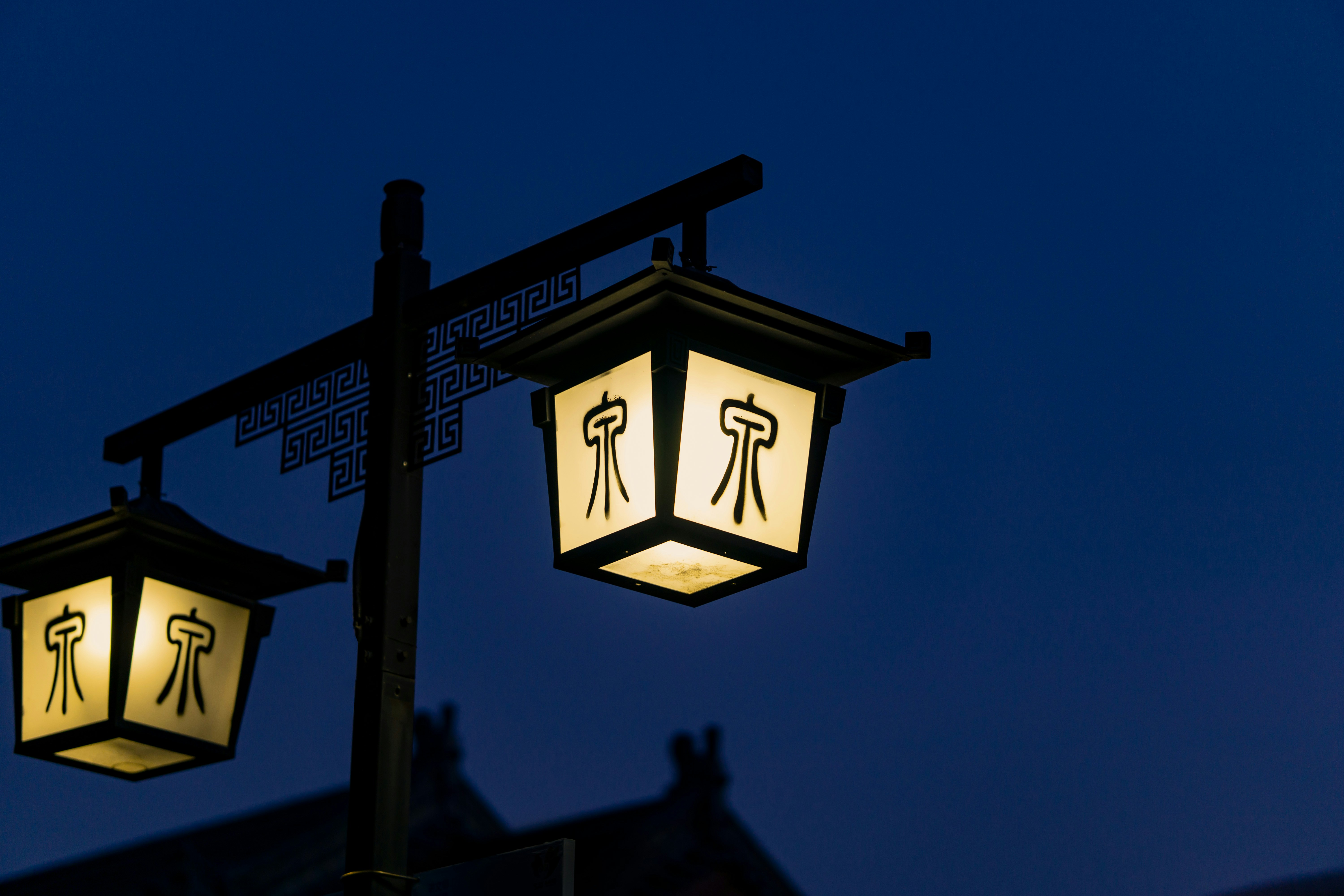 Traditional lanterns glowing softly against a twilight sky, showcasing intricate designs and cultural significance.