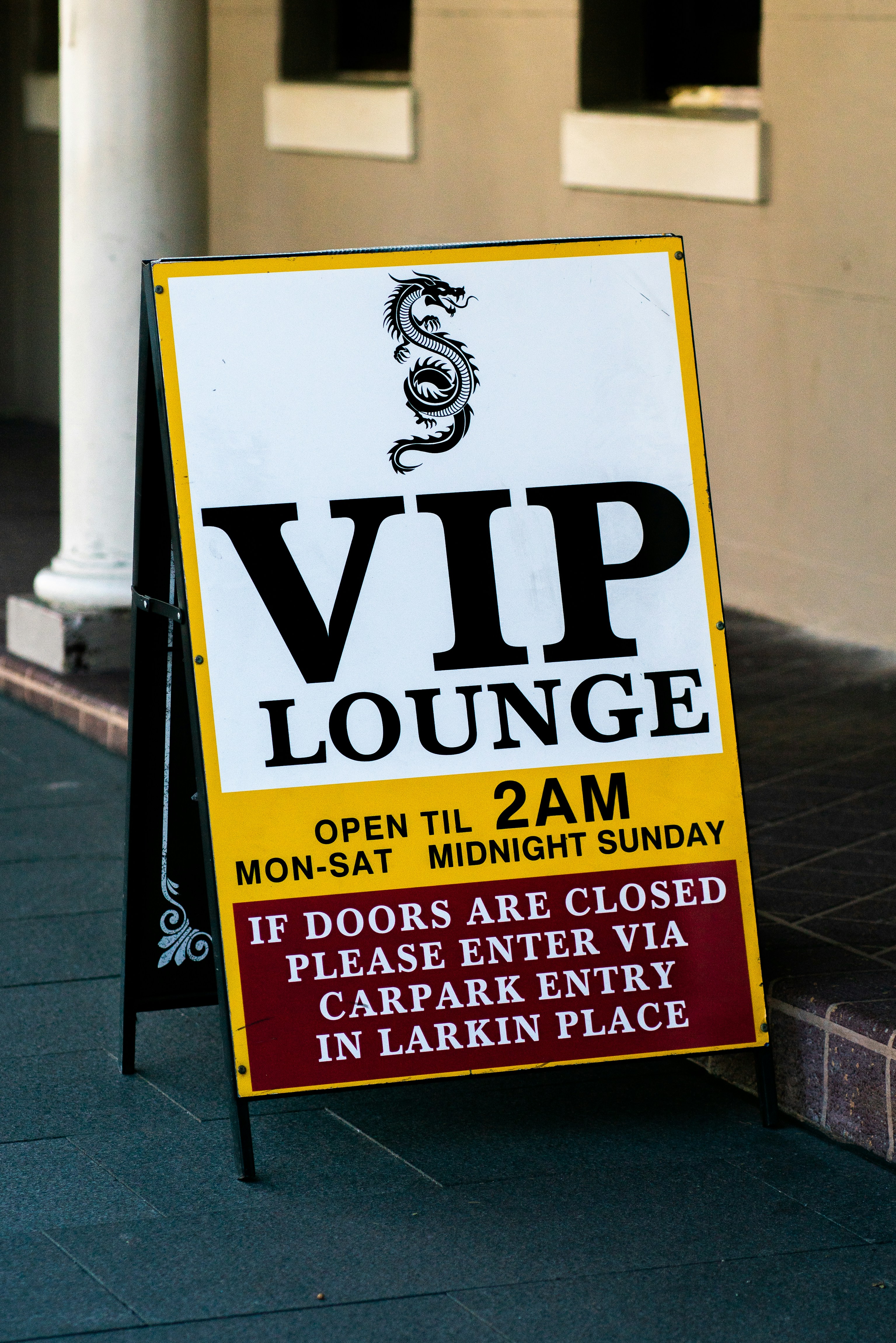 A sign on the side of a building that says, vip lounge open till photo ...