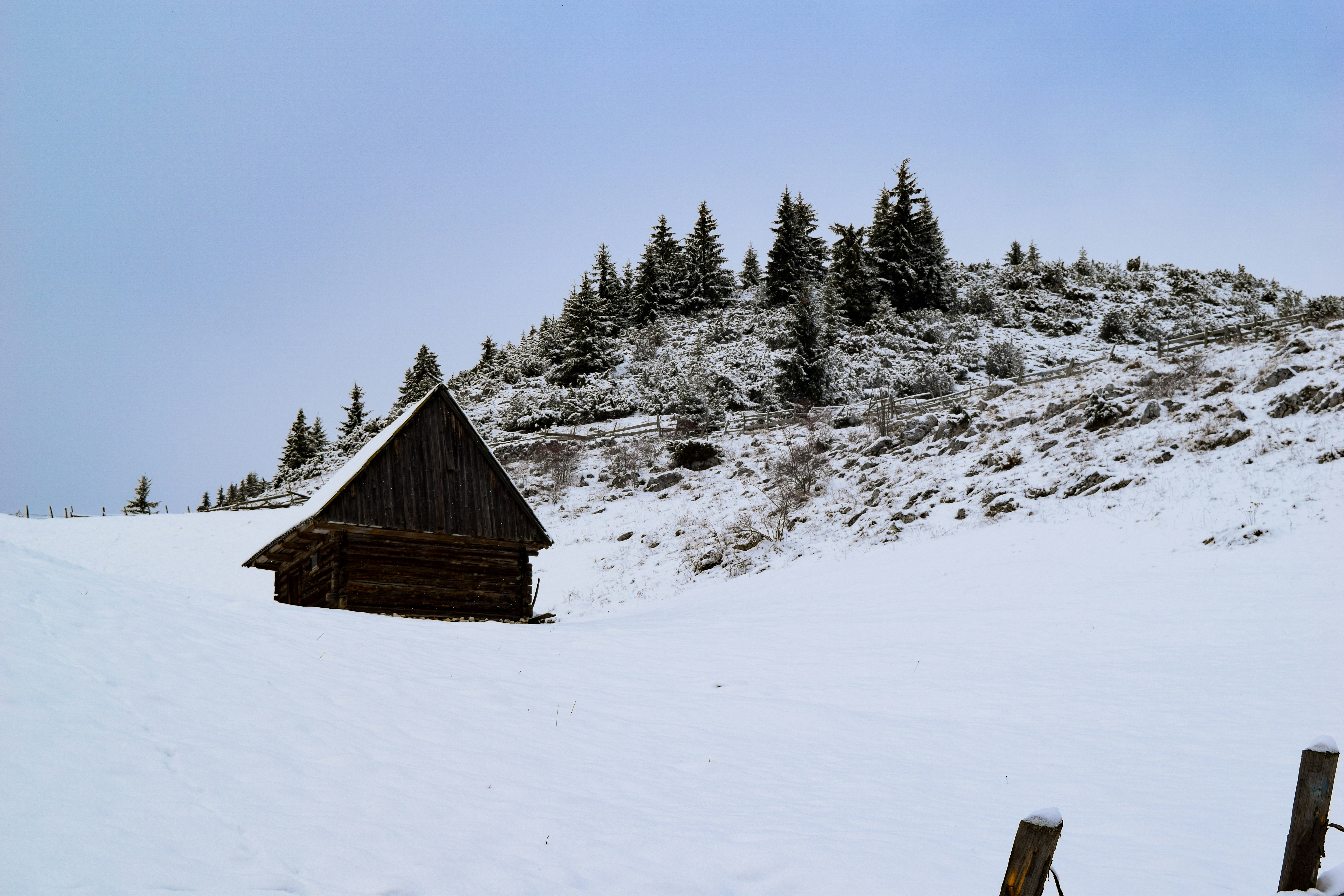 a cabin in the middle of a snowy mountain