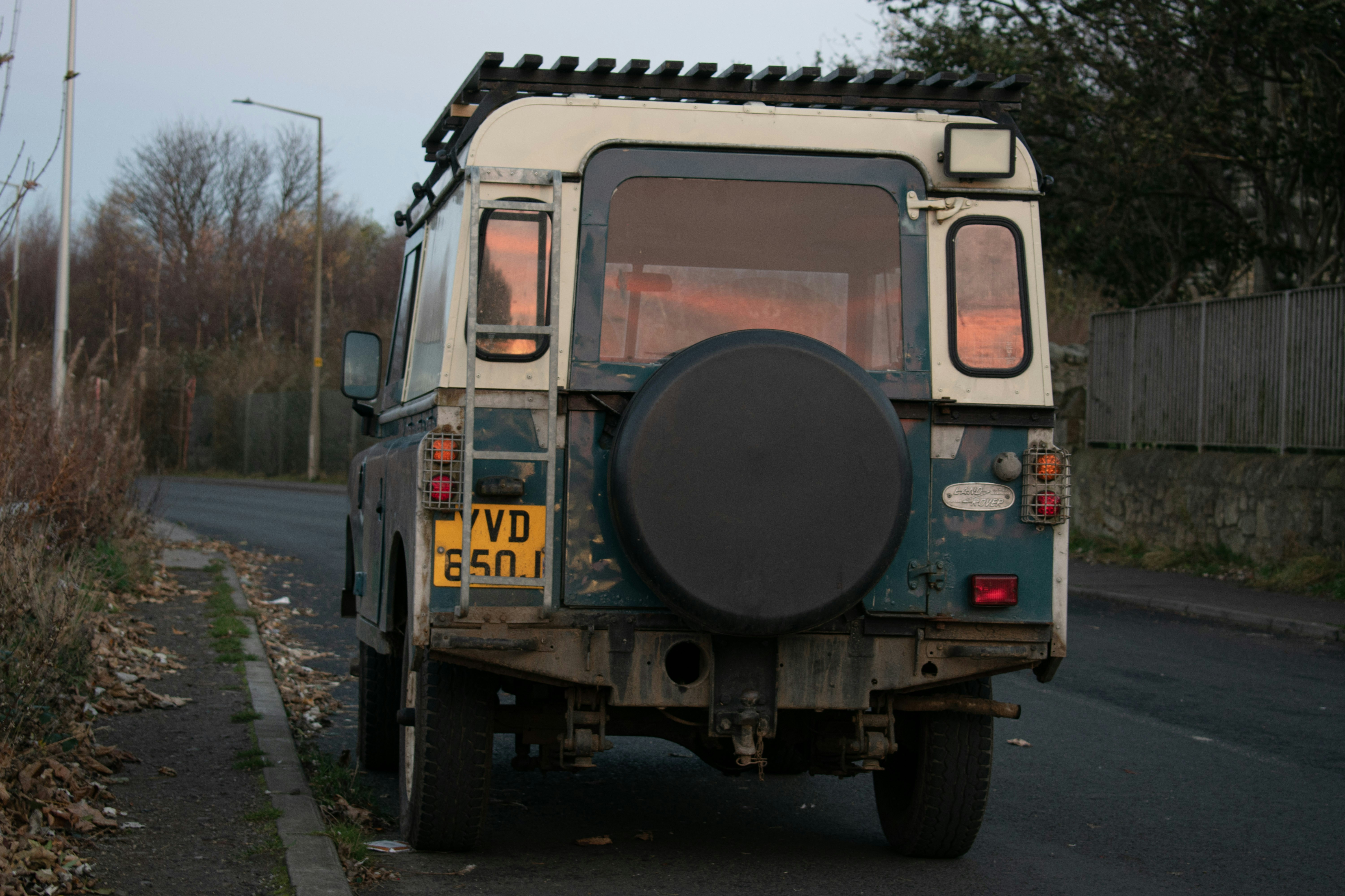 Classic off-road vehicle parked on a quiet street, showcasing its rugged design and vintage charm.
