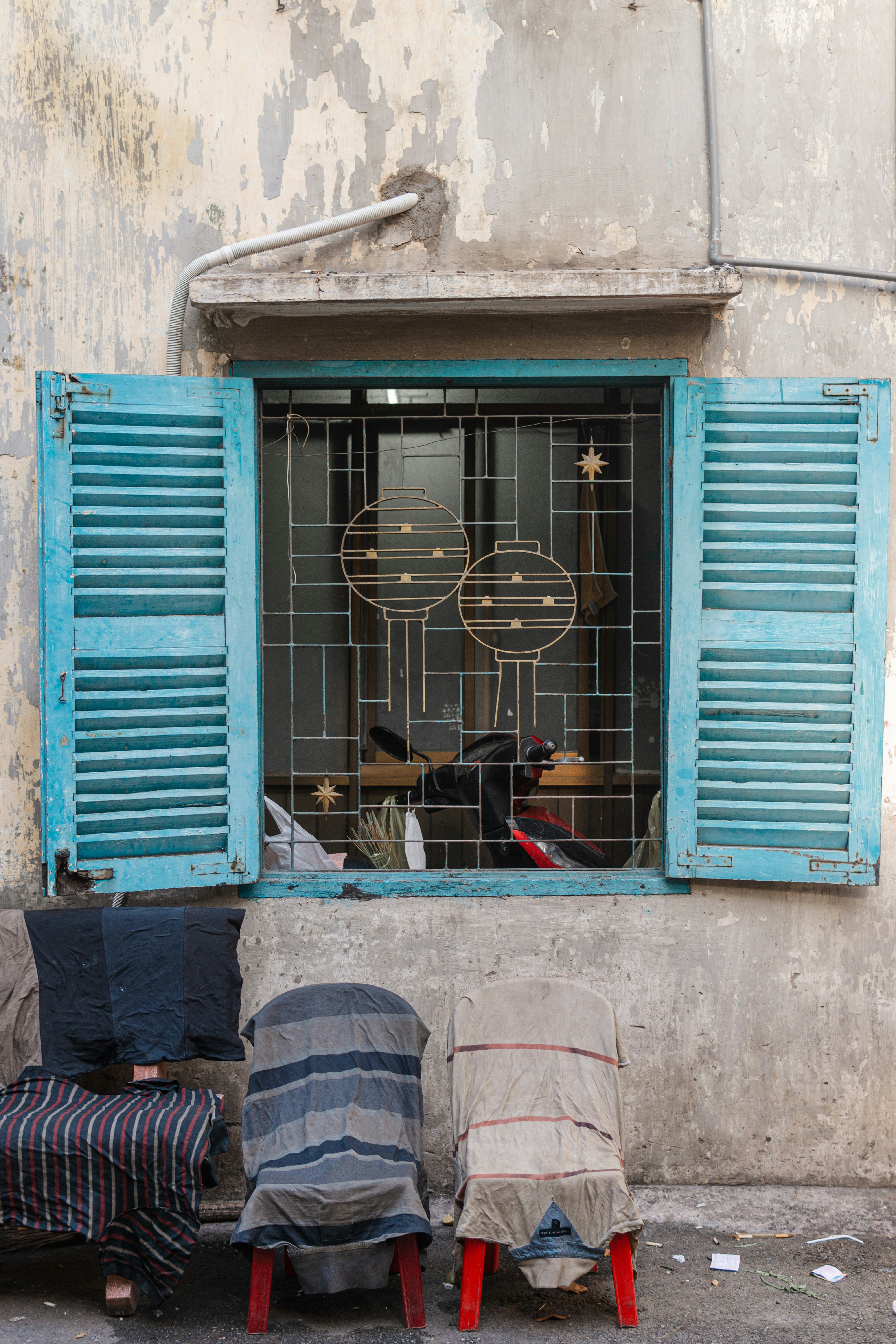 Azure Shutter Window: A Quiet Courtyard’s Geometric Gaze