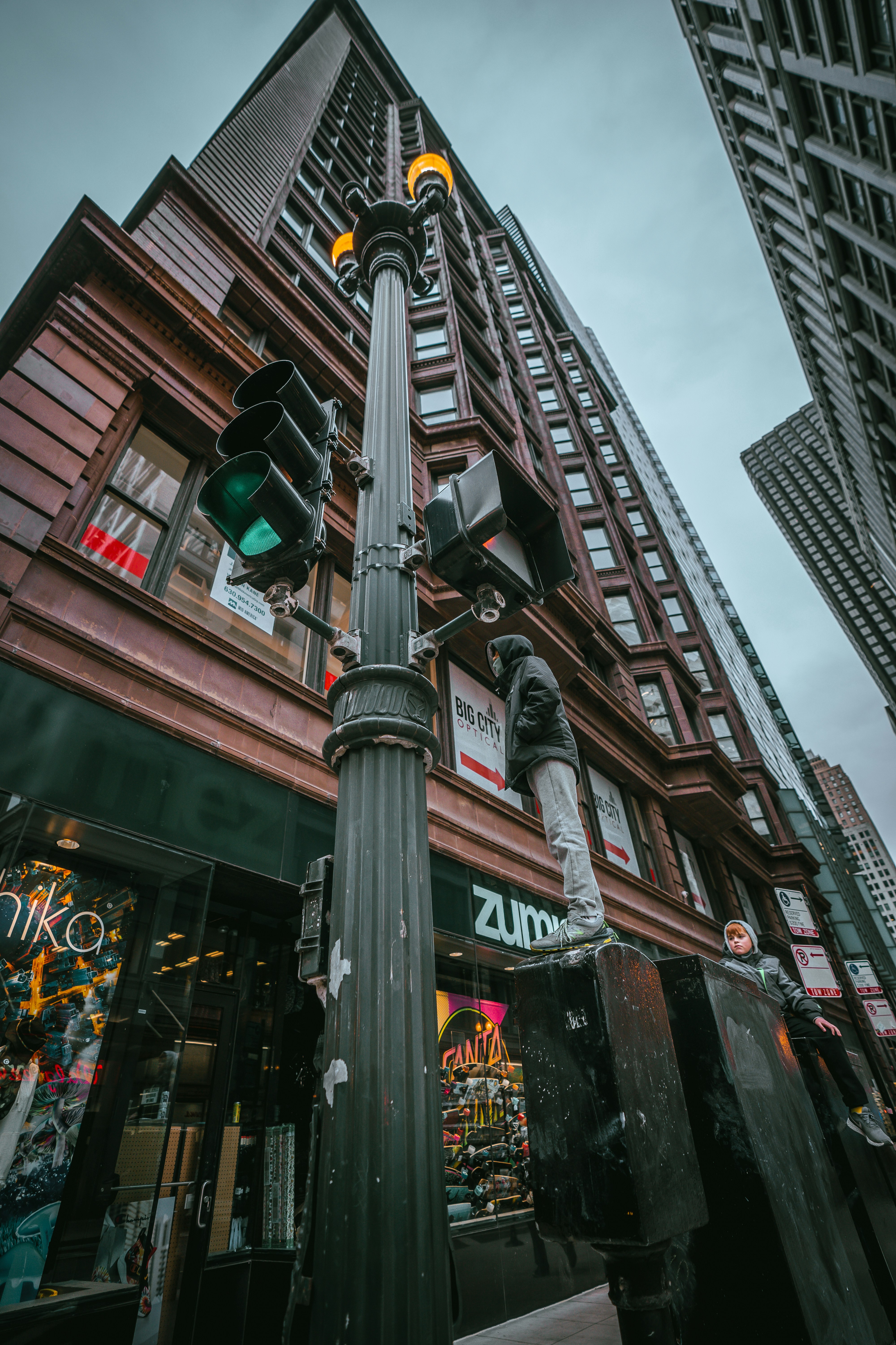 Boy standing on top of electrical box in downtown Chicago